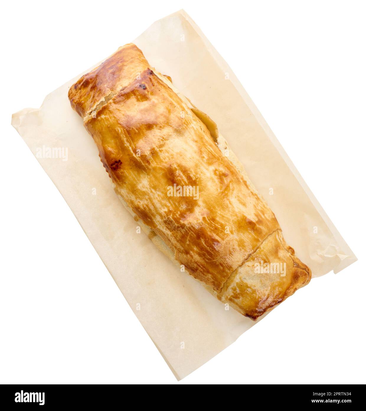 Whole baked strudel with fruit filling on parchment paper isolated on ...