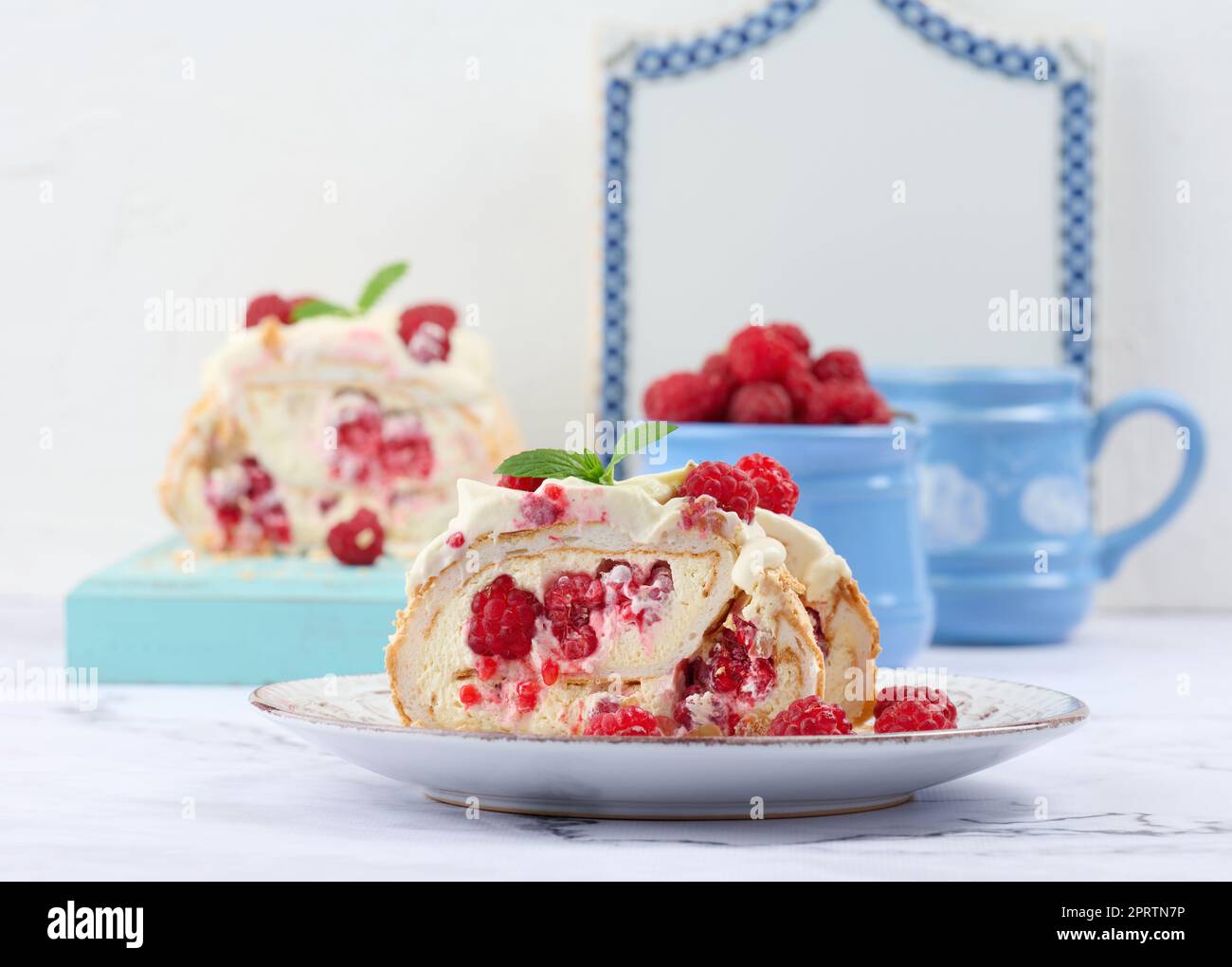 Baked meringue roll with cream and fresh red raspberry, white ...