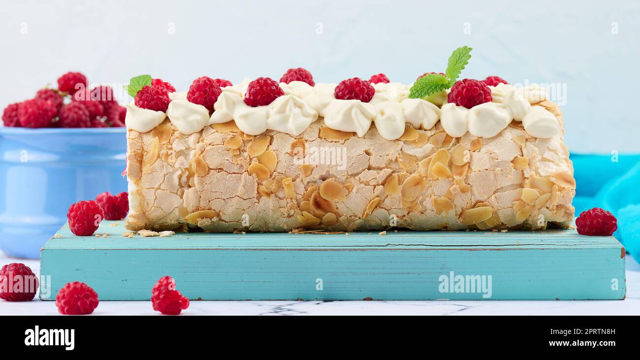 Baked meringue roll with cream and fresh red raspberry, white ...