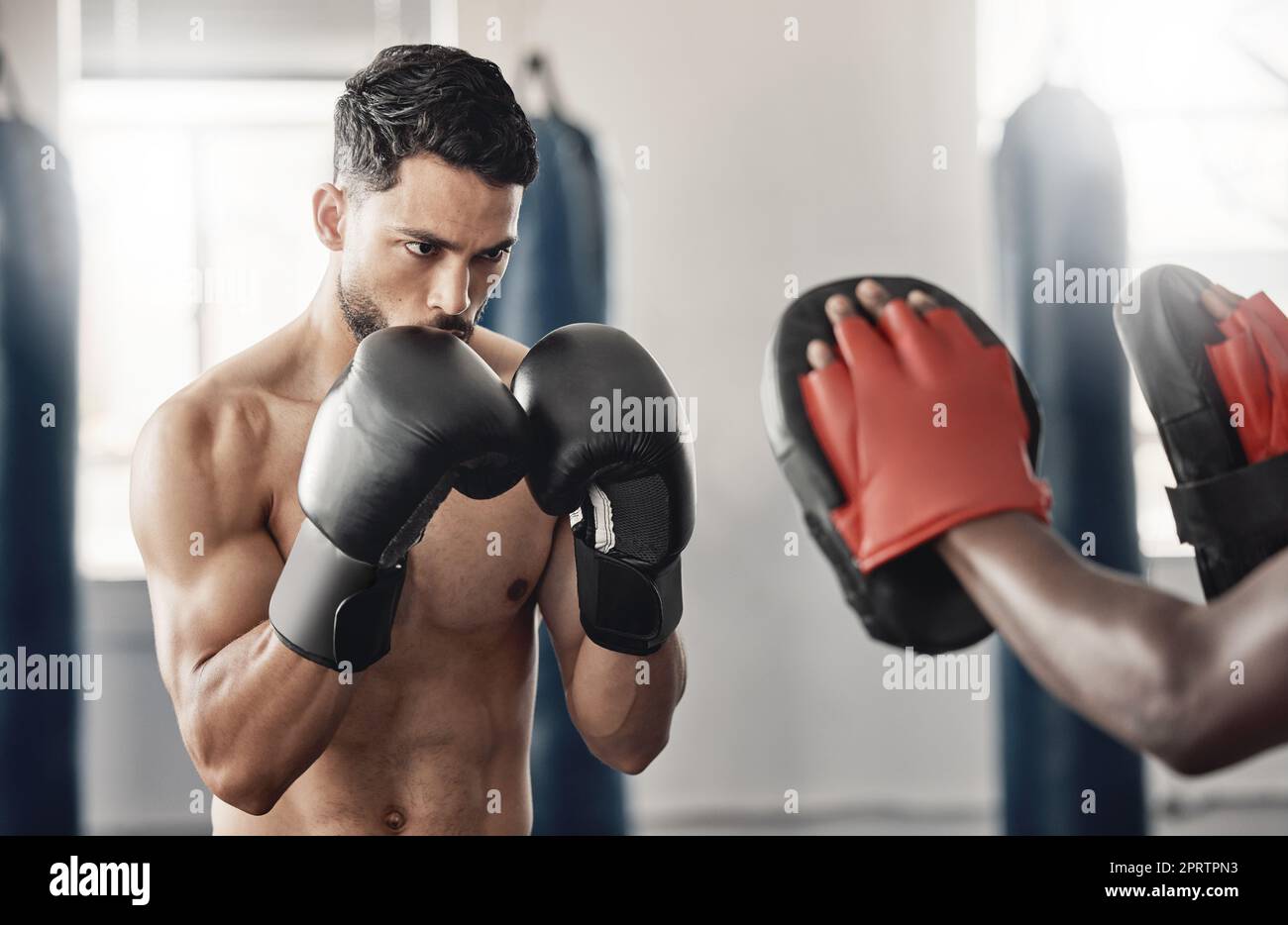 Boxing gym, fighting pad and man training with athlete coach for a ...
