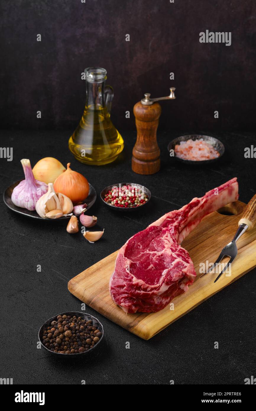 Raw beef cowboy steak with spice ready for cooking Stock Photo - Alamy