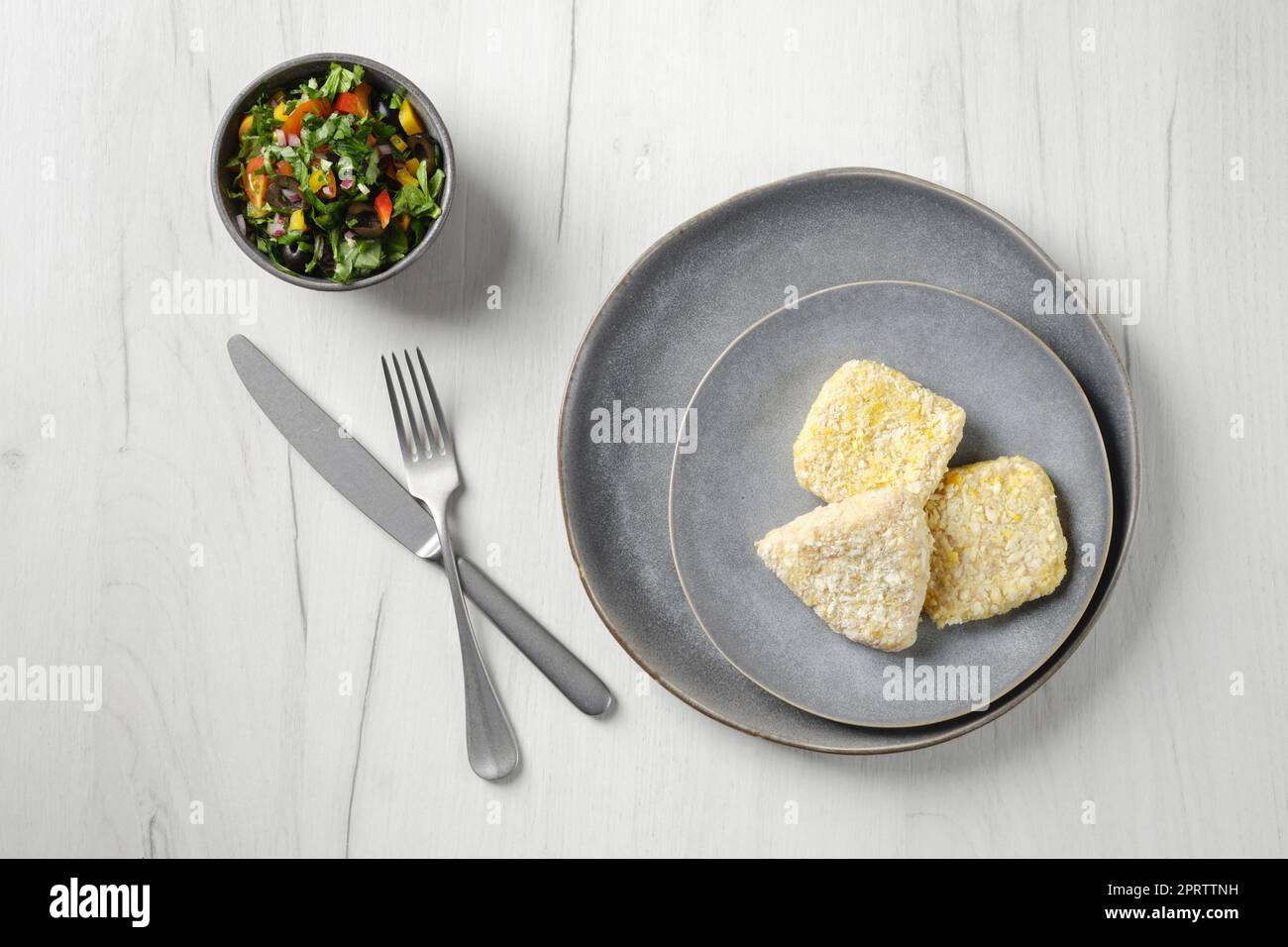 Top view of semifinished squid cutlet in breading Stock Photo - Alamy