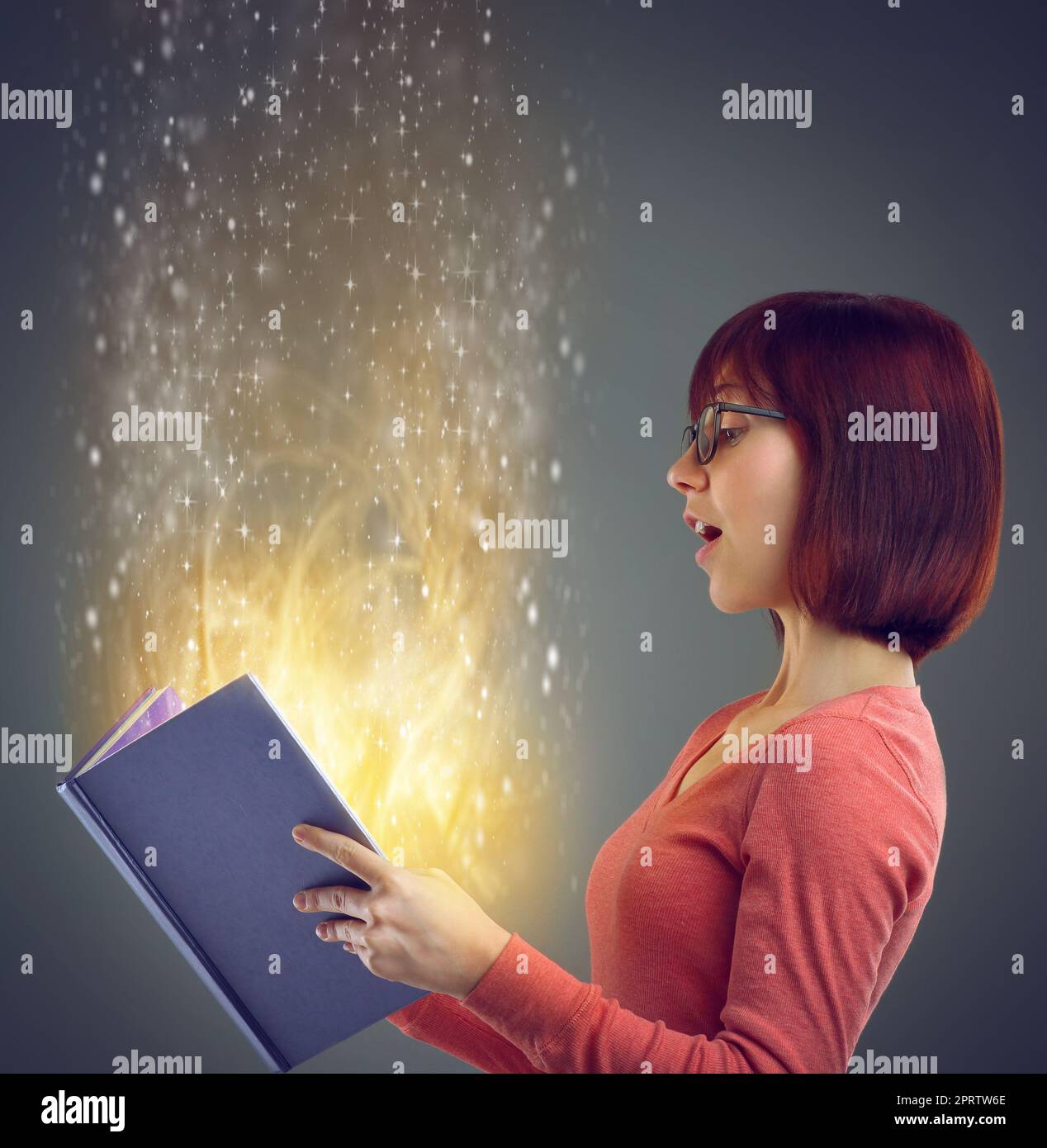 Discovering a world of magic. A cropped shot of a young adult reading a ...