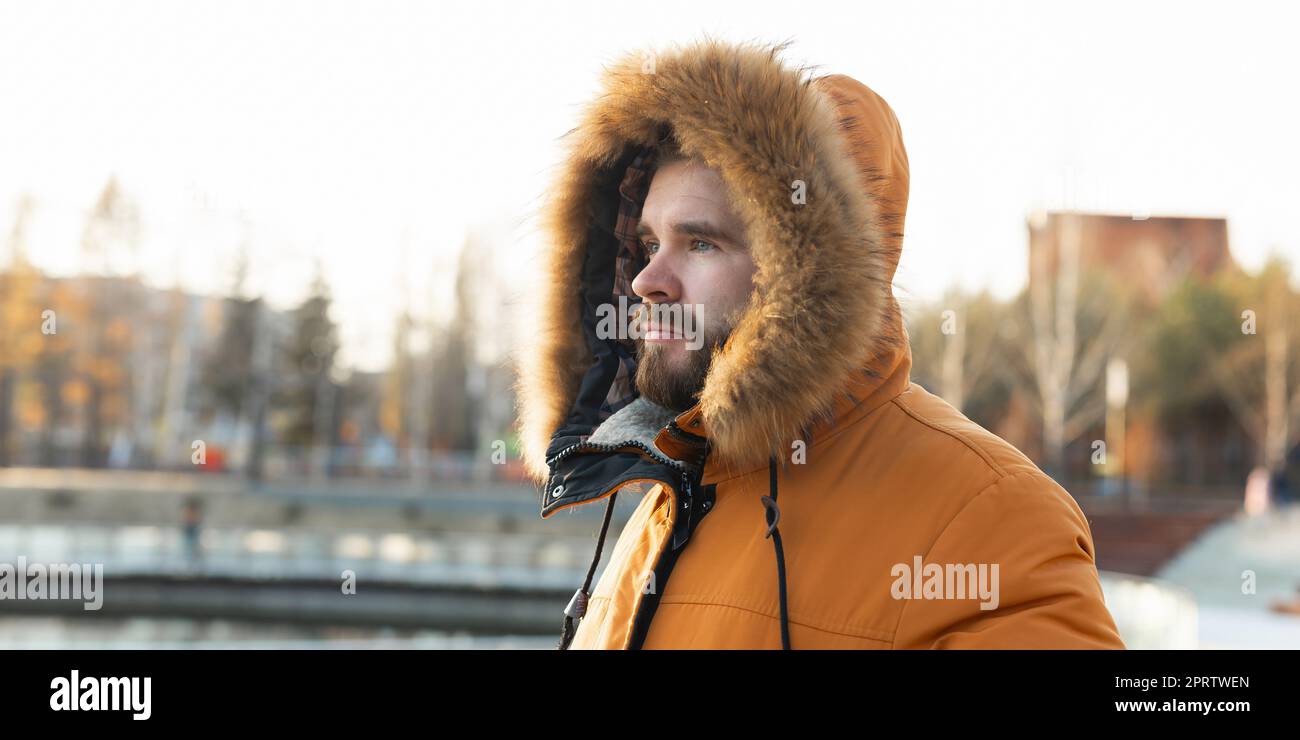 Winter is coming, Man wearing winter jacket on cold park background ...