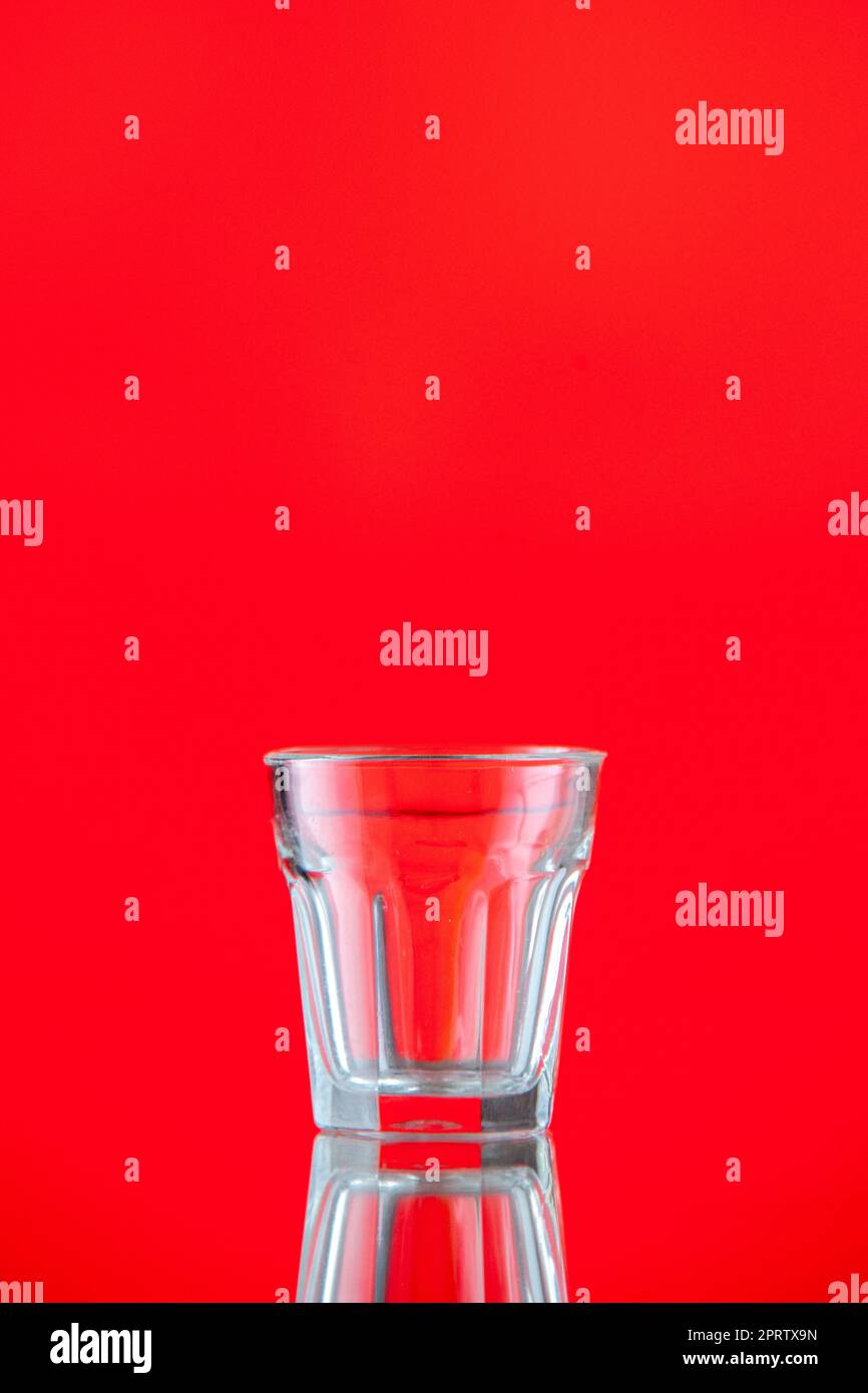 front view water glass on red isolated background Stock Photo - Alamy