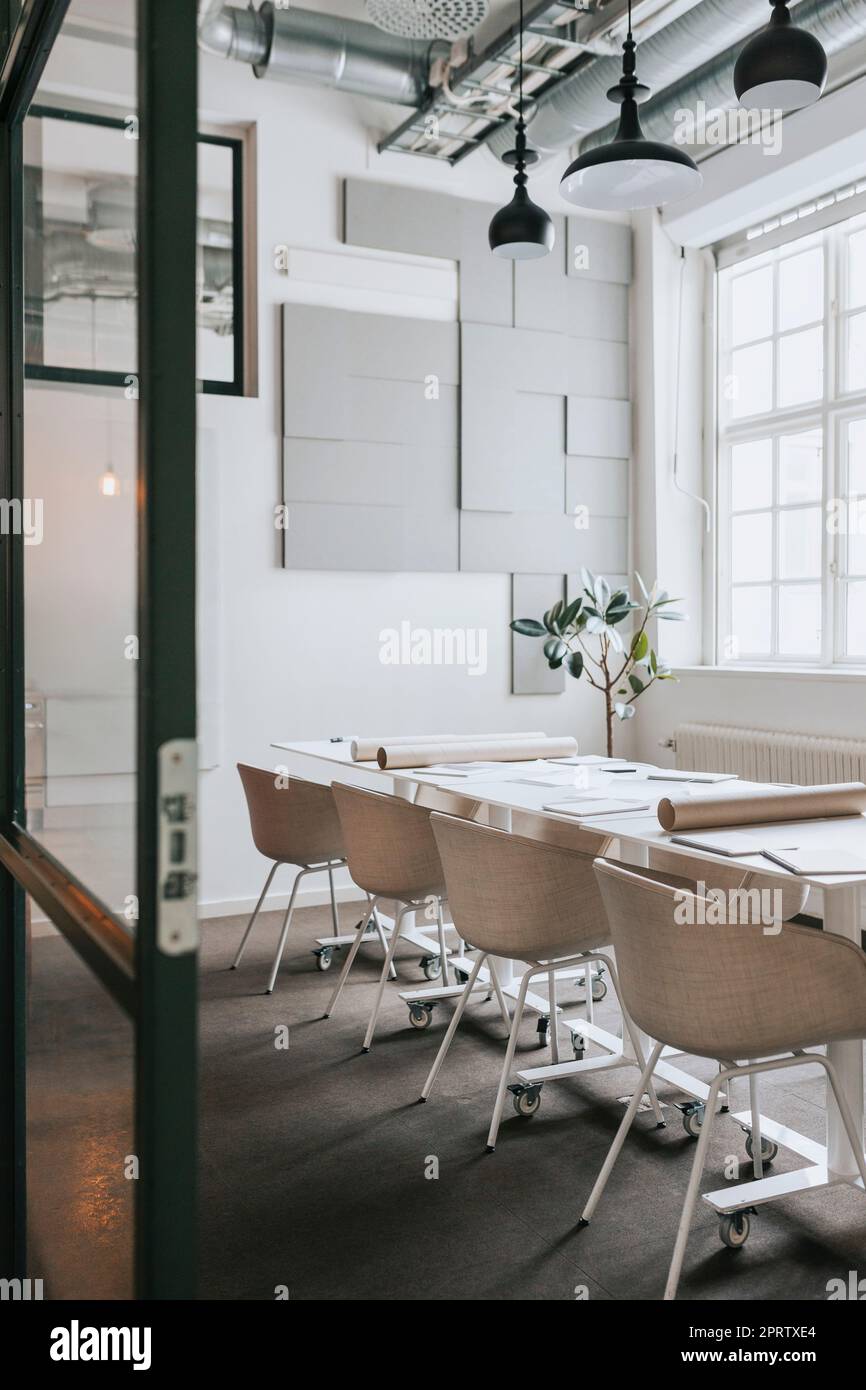 Chairs and tables arranged in empty meeting room at office Stock Photo ...