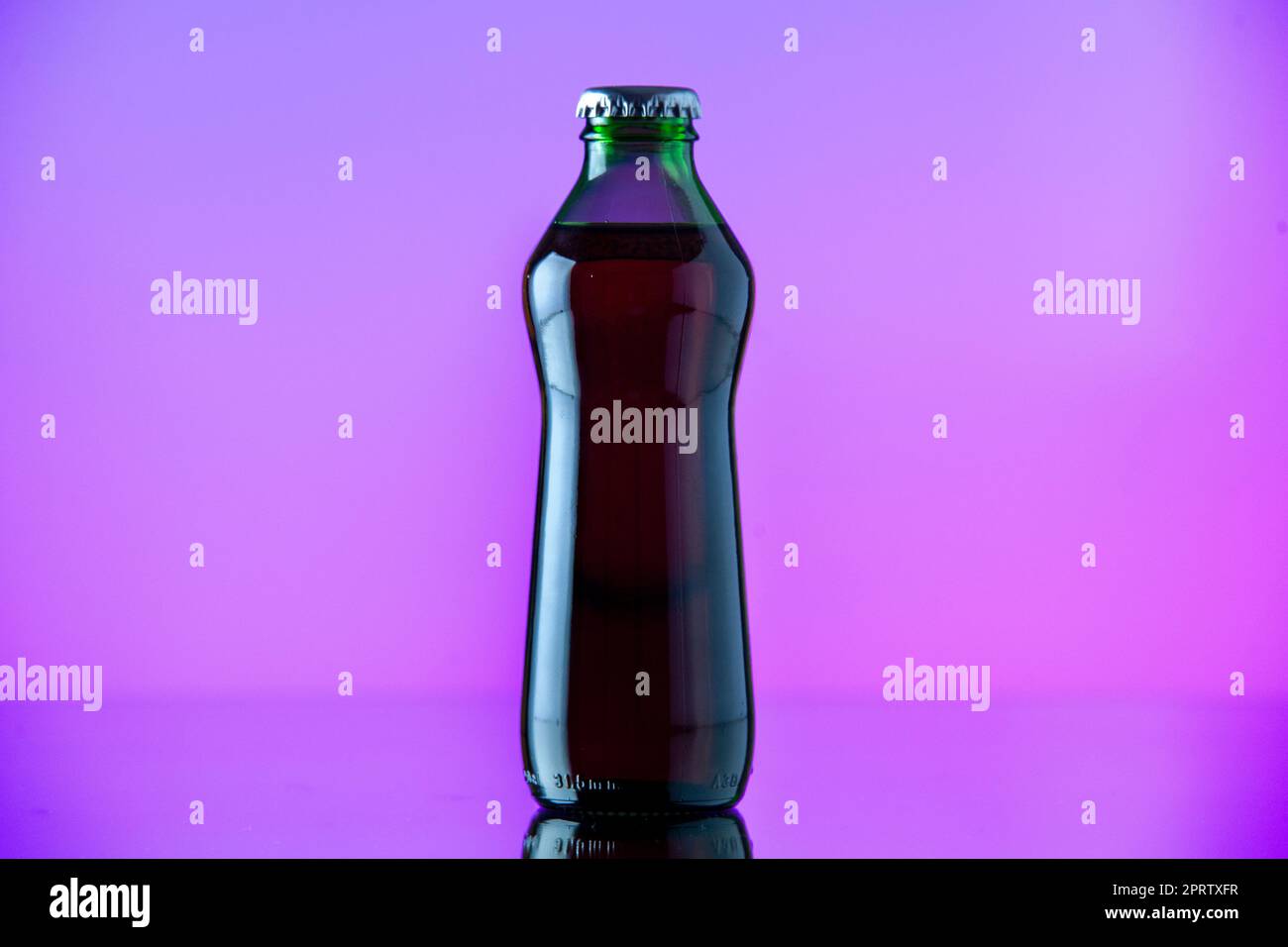 front view soda drink glass bottle on purple background Stock Photo - Alamy