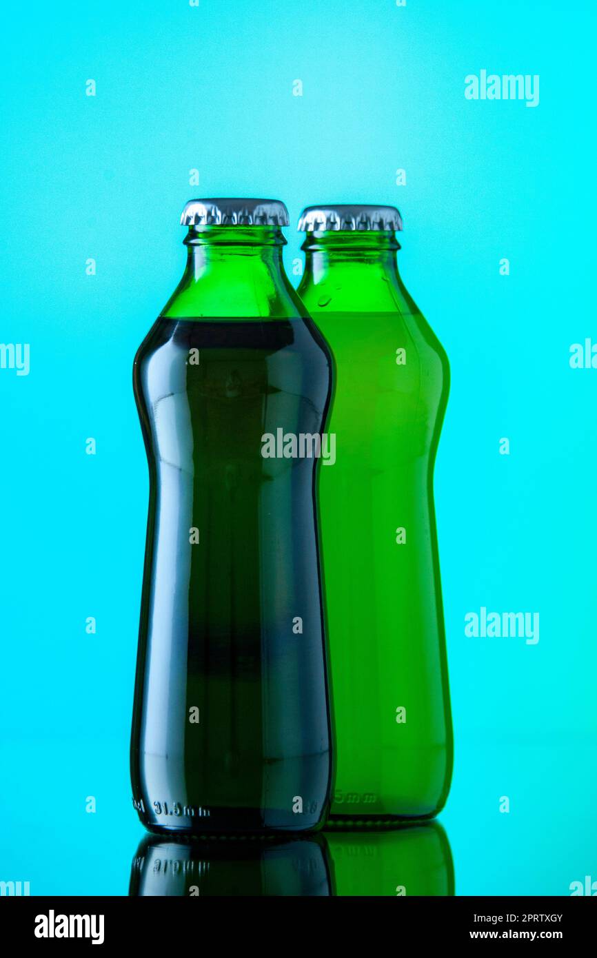 front view soda drink glass bottles on light blue background Stock ...