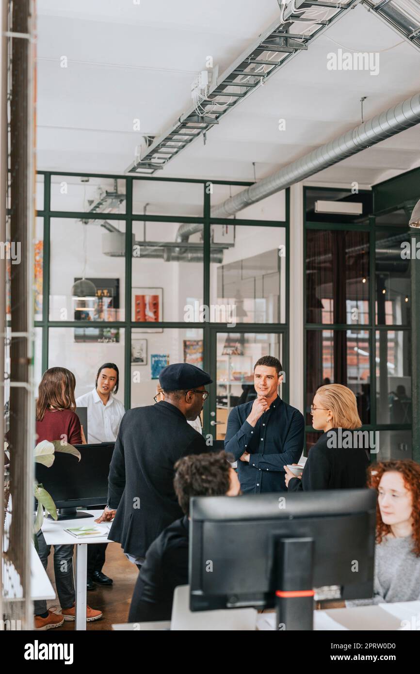 Multiracial male and female business people during meeting at work ...