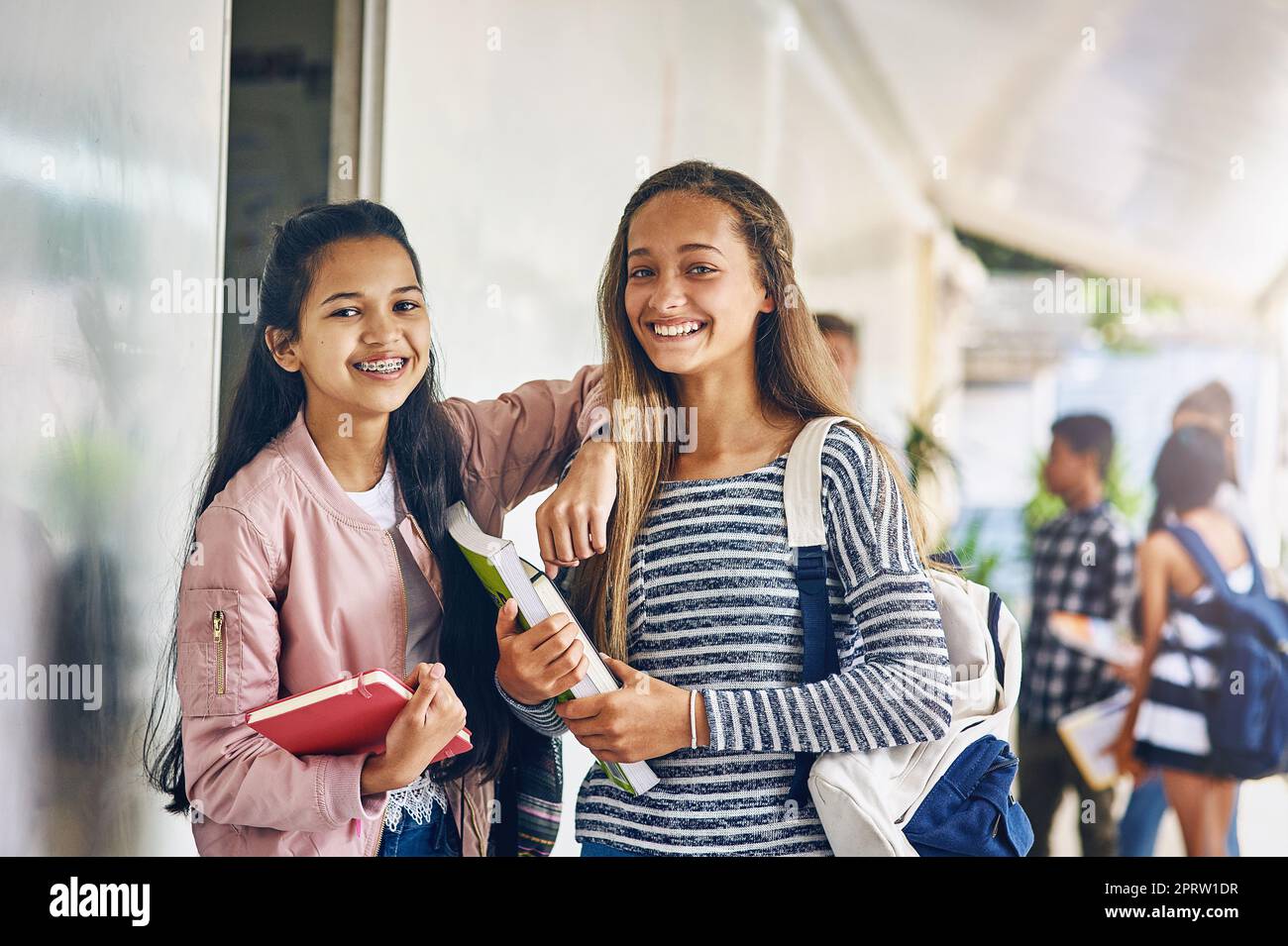 Were too cool for school. Portrait of two happy schoolgirls standing ...