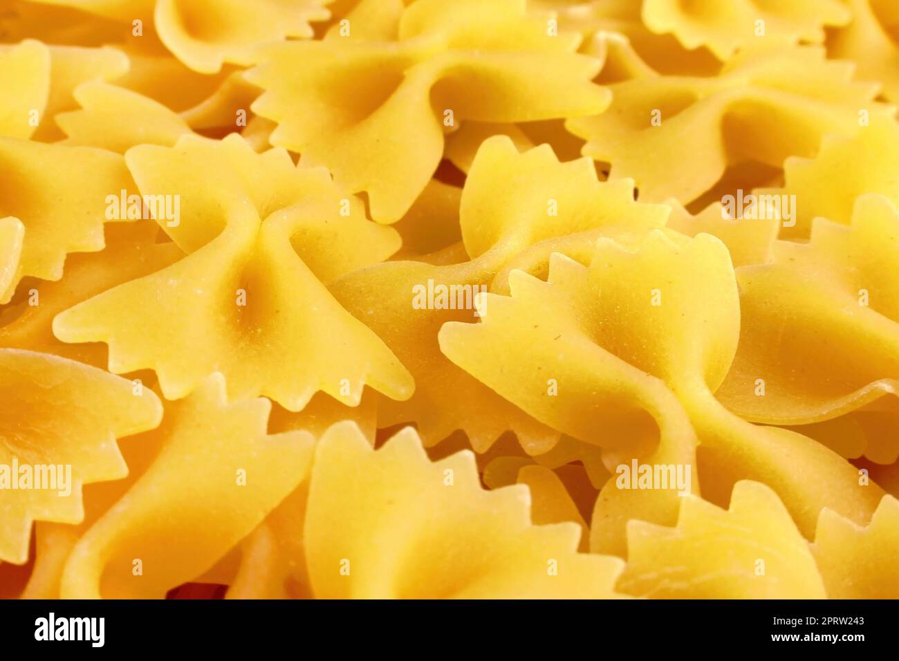 Yellow uncooked Italian butterfly farfalle pasta texture close up Stock ...