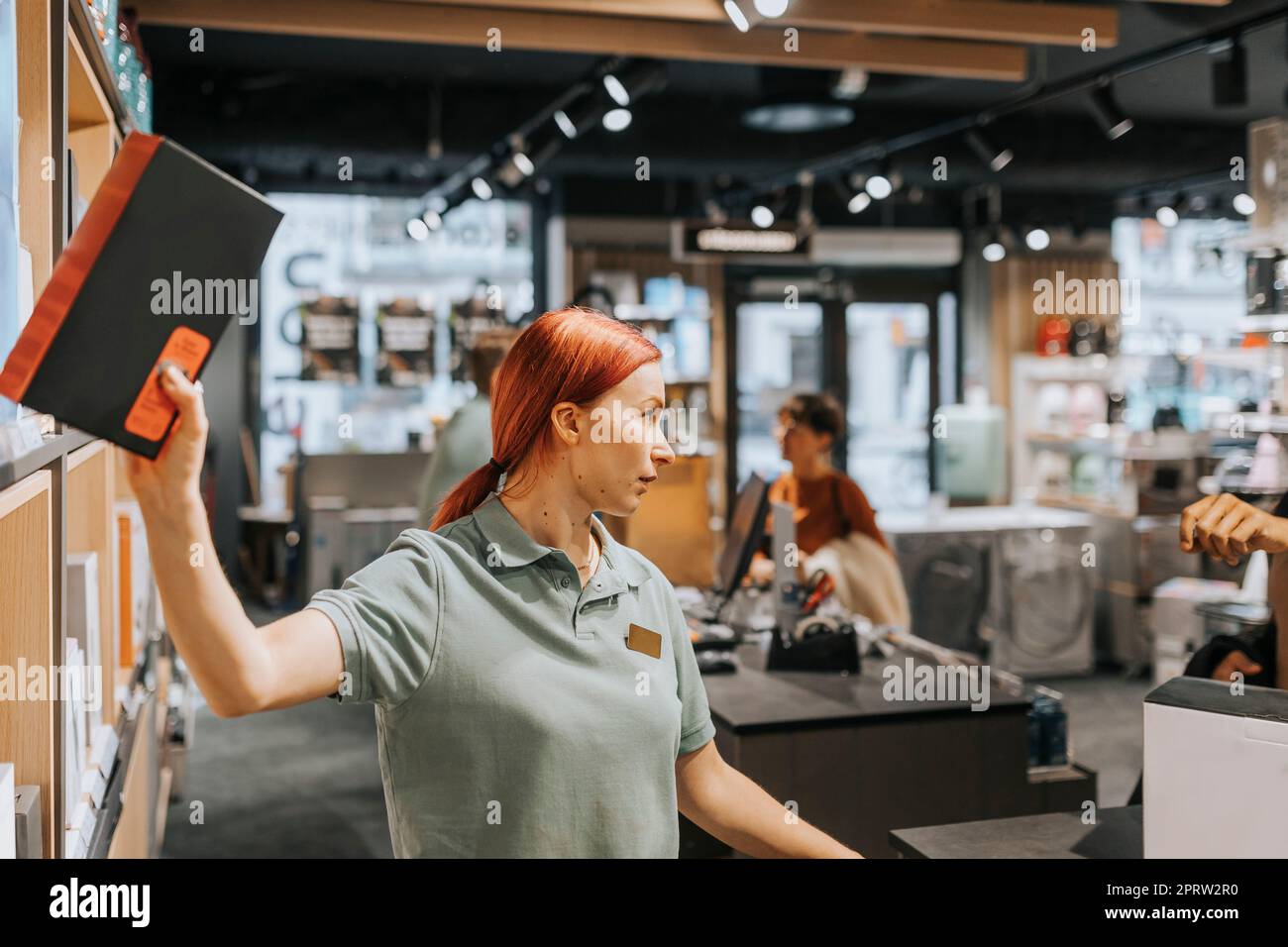 Redhead female sales clerk hi-res stock photography and images - Alamy
