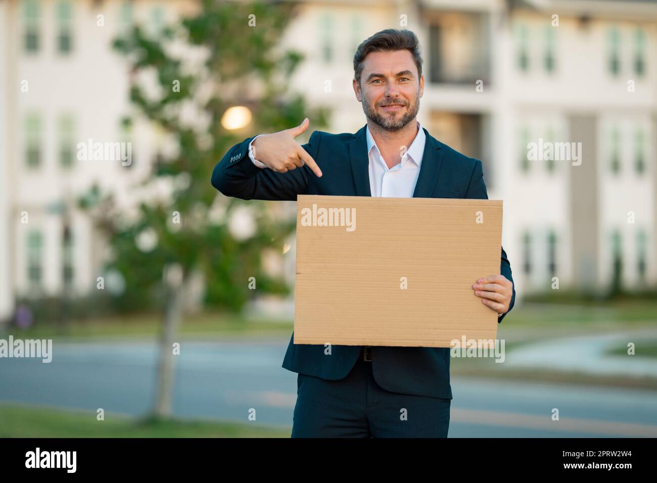 Man in business suit holds the sign, blank card. Placard ready for your ...