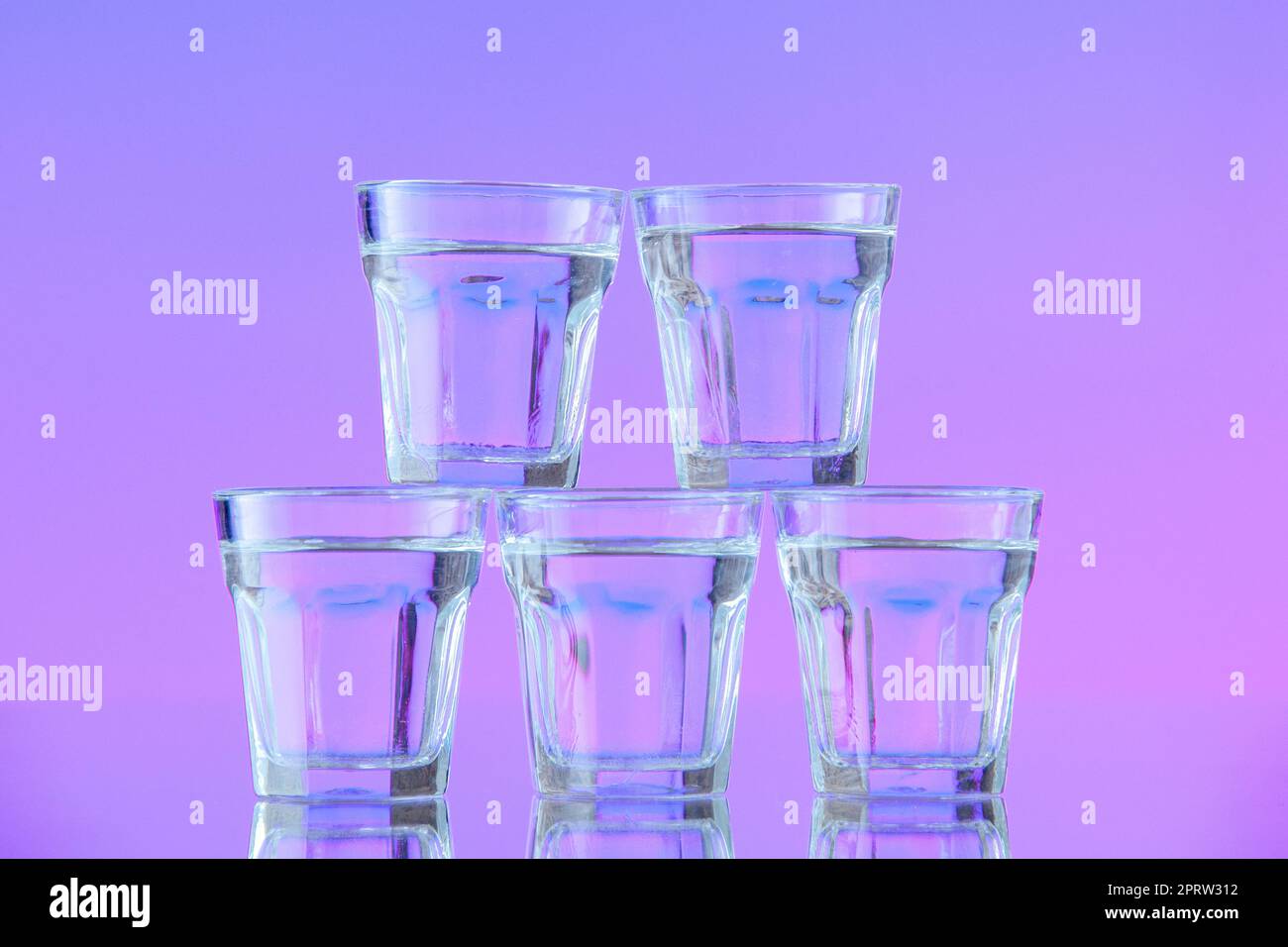 front view water glasses stacked on top of each other on purple ...