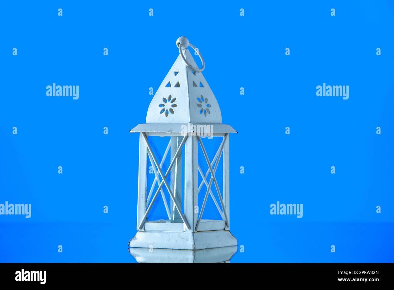 front view small white wooden lantern on blue background free space ...