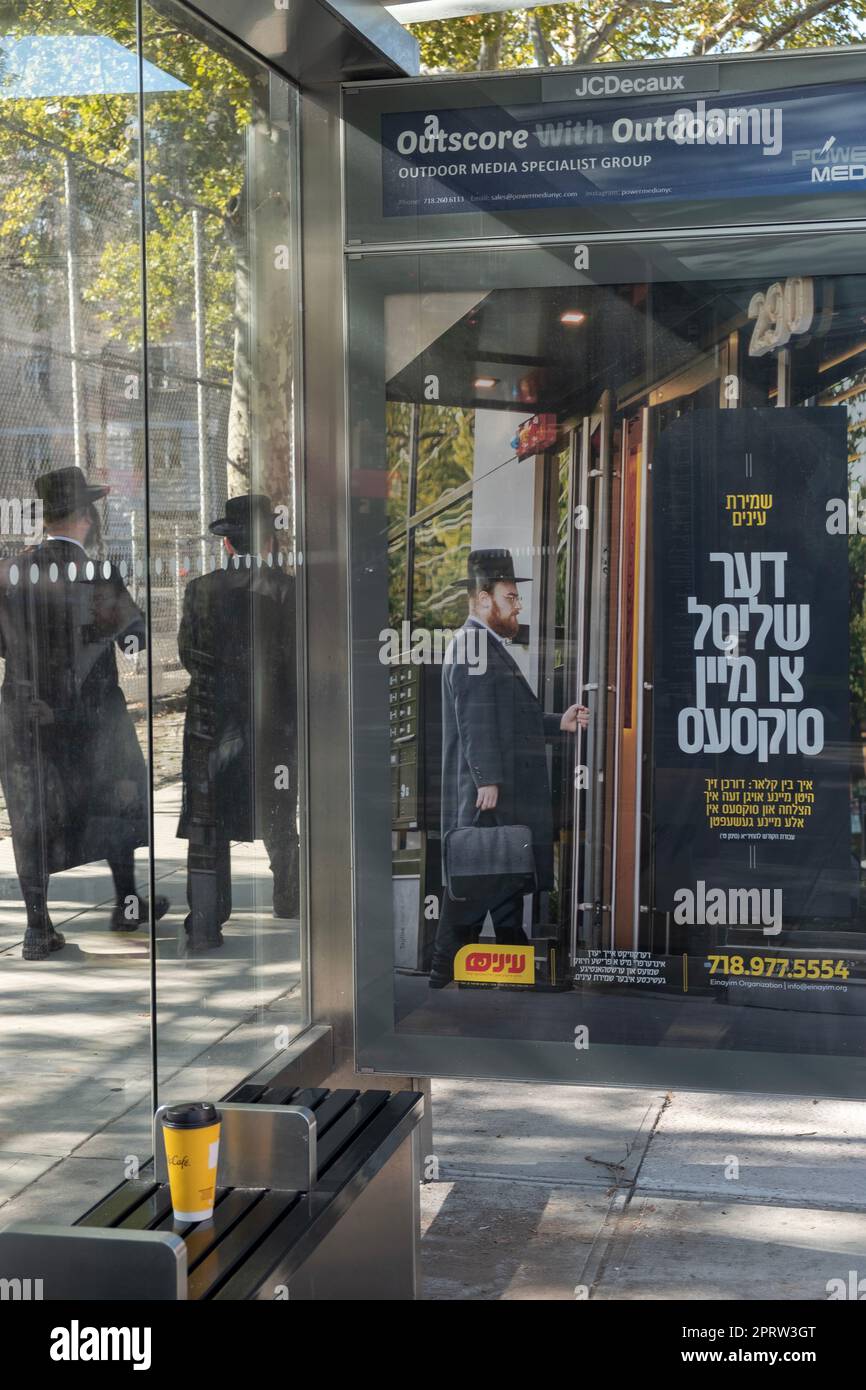A bus kiosk with a Yiddish sign from einayim.com saying the key to my ...