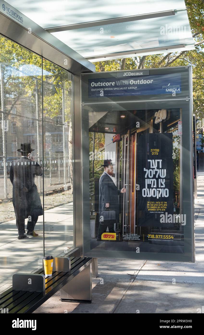 A bus kiosk with a Yiddish sign from einayim.com saying the key to my ...