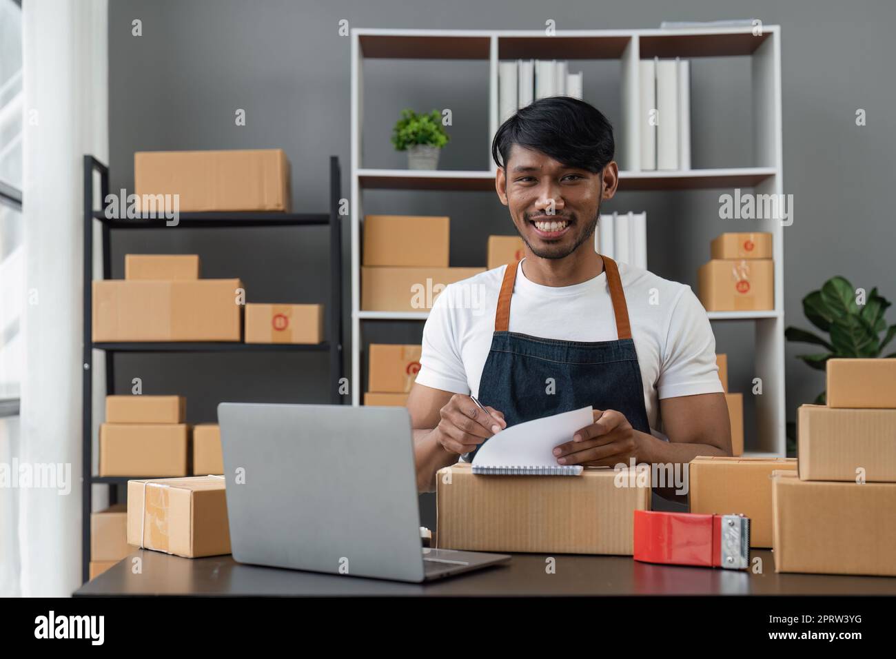 Online business ideas Asian man selling things online holding parcel ...