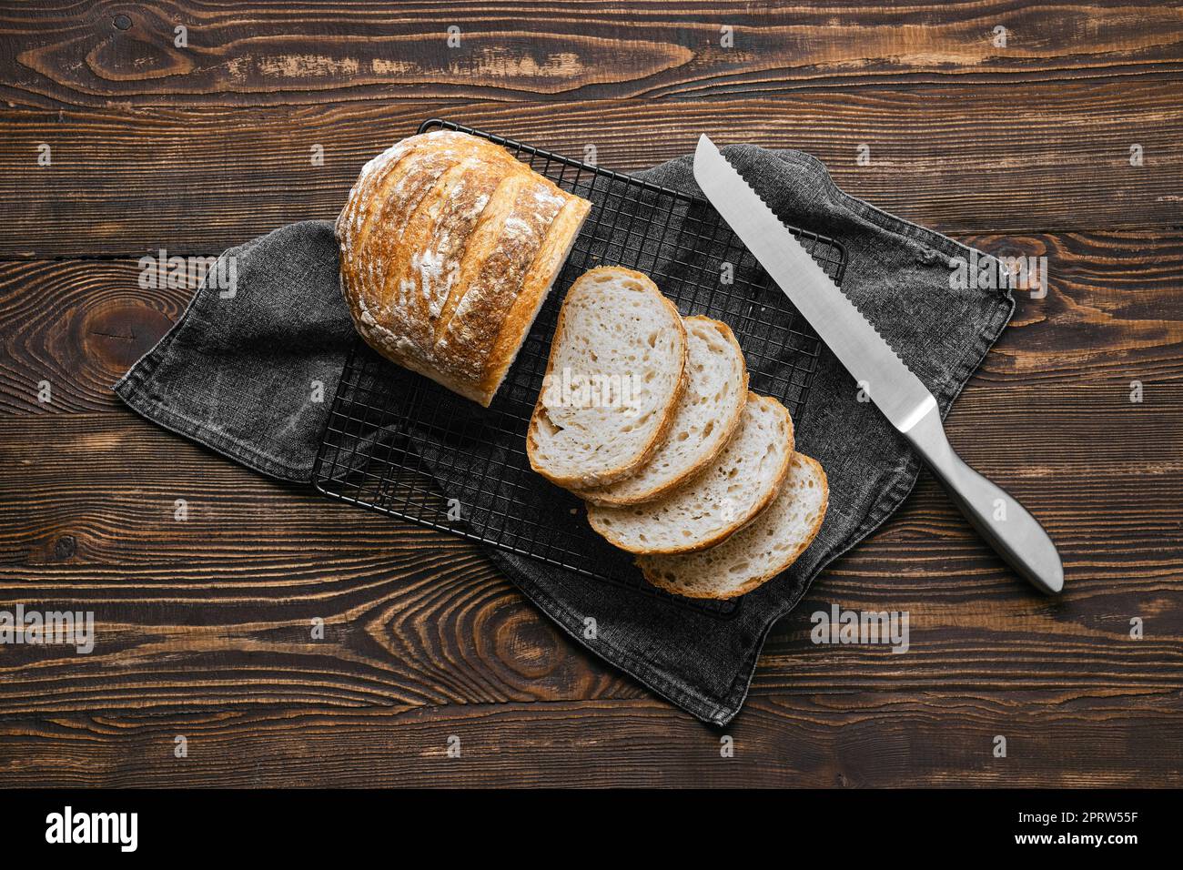 Top view of artisan whole grain wheat bread cut on slices on kitchen ...