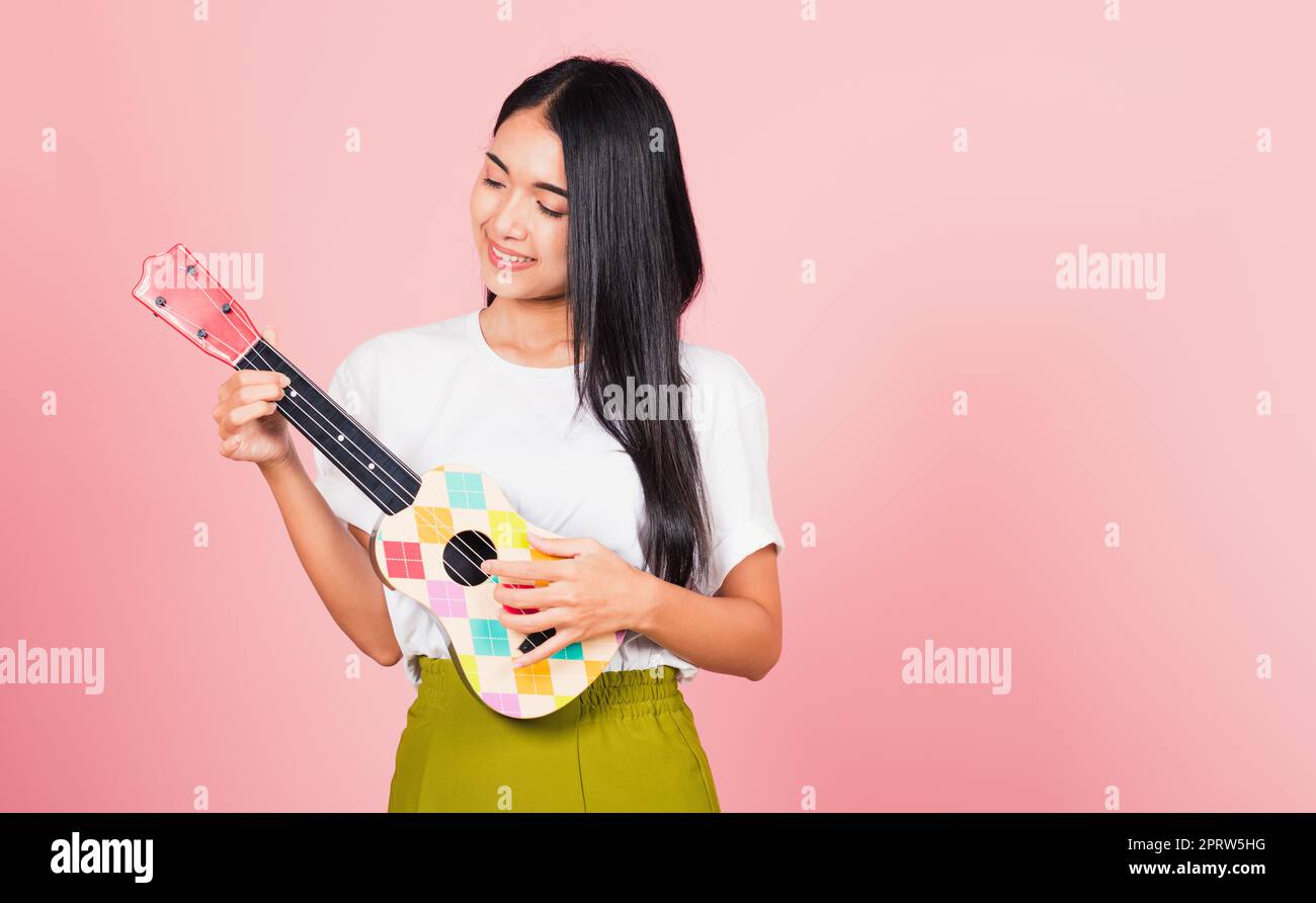 woman teen confident smiling face hold acoustic Ukulele guitar Stock ...