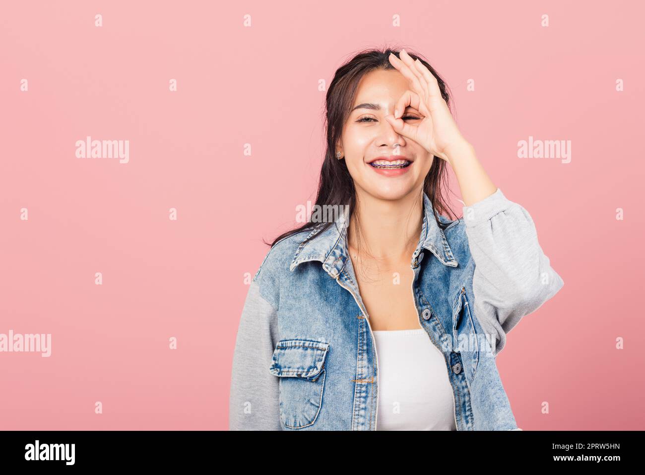 woman standing, She made finger OK symbol sign to agree Stock Photo - Alamy
