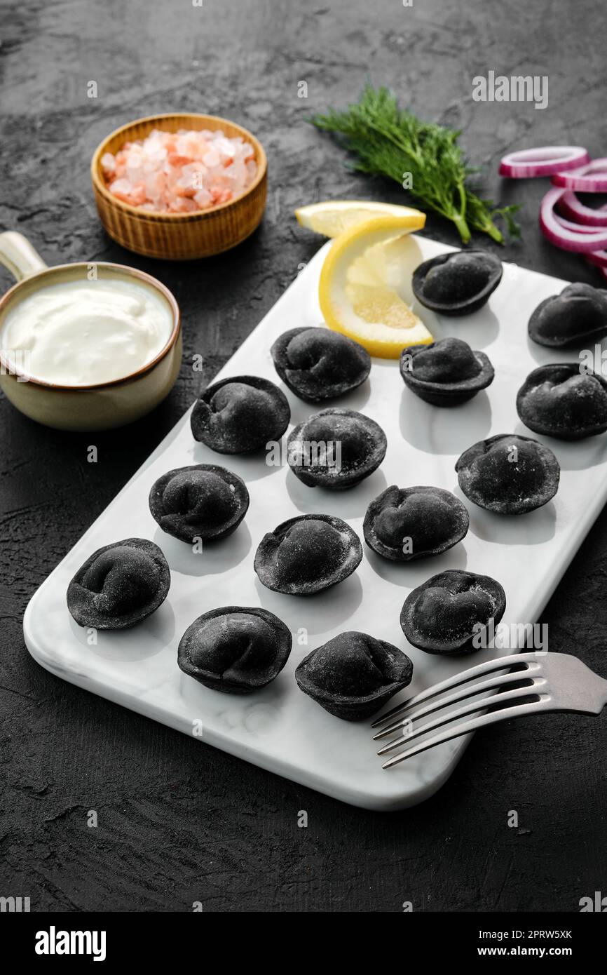 Black dumplings with beef with dough with cuttlefish ink Stock Photo ...