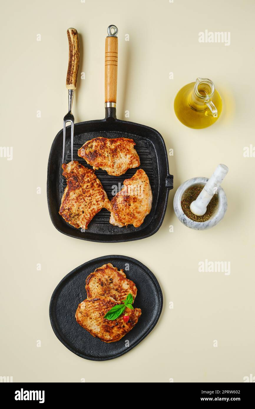 Top view of fried chopped pork tenderloin on plate and pan Stock Photo ...