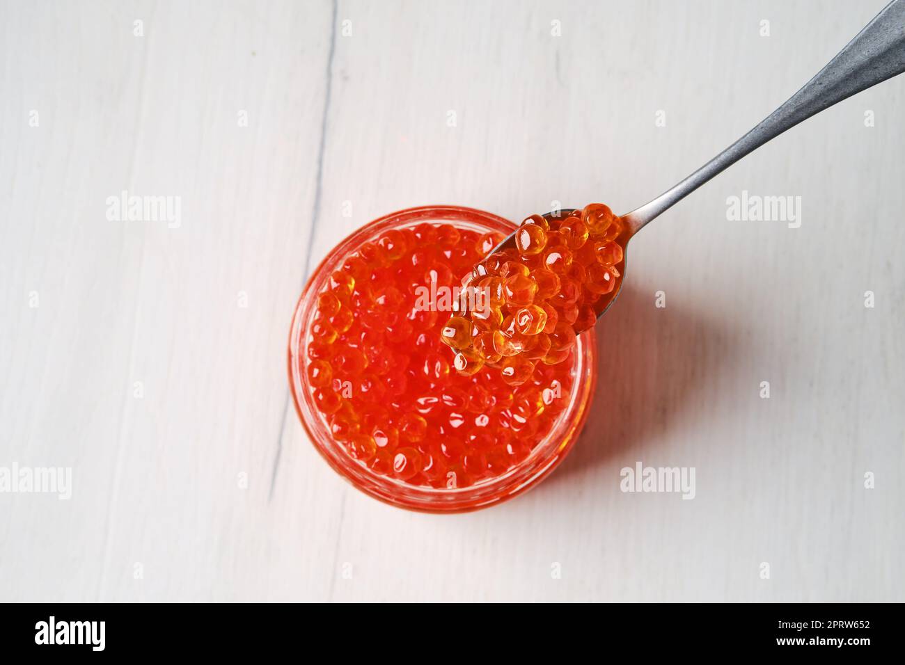 Top view of open jar with red caviar and a spoon above it Stock Photo ...