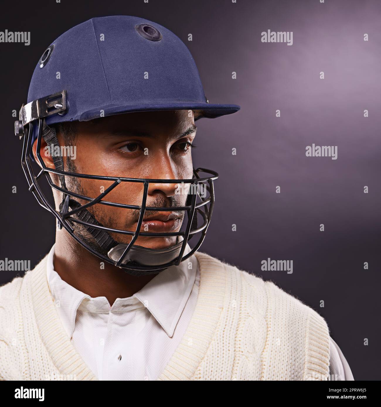 Focused on the game. A cropped shot of an ethnic young man in cricket ...
