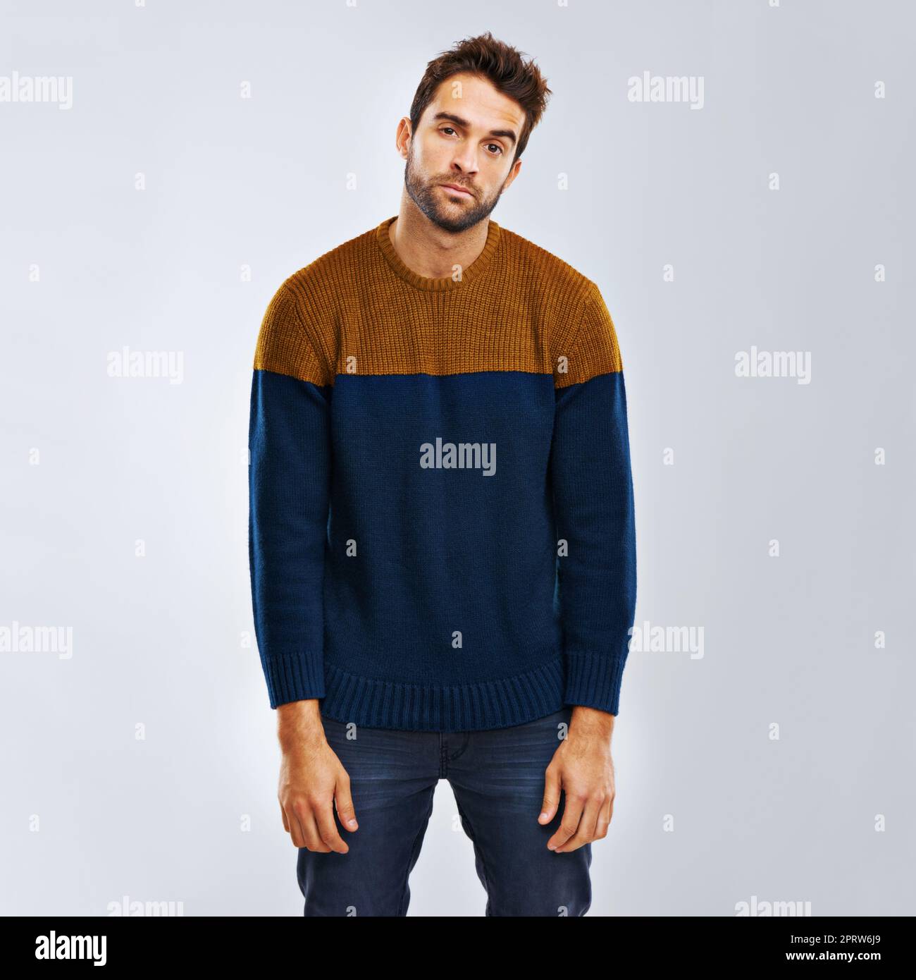 Feeling blue. Studio shot of a young man looking miserable against a ...