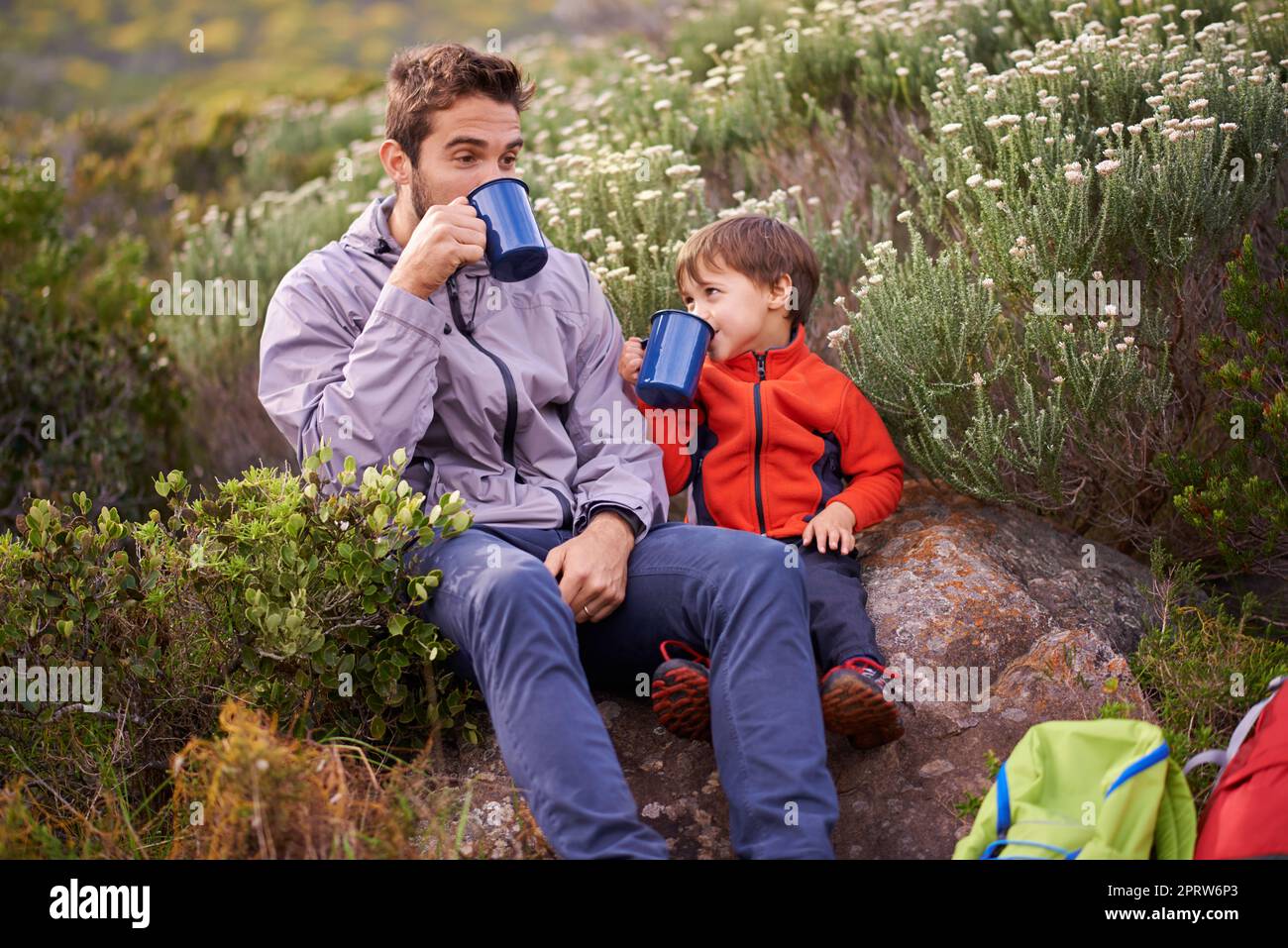 Lets take a load off. a happy father and son having something to drink ...