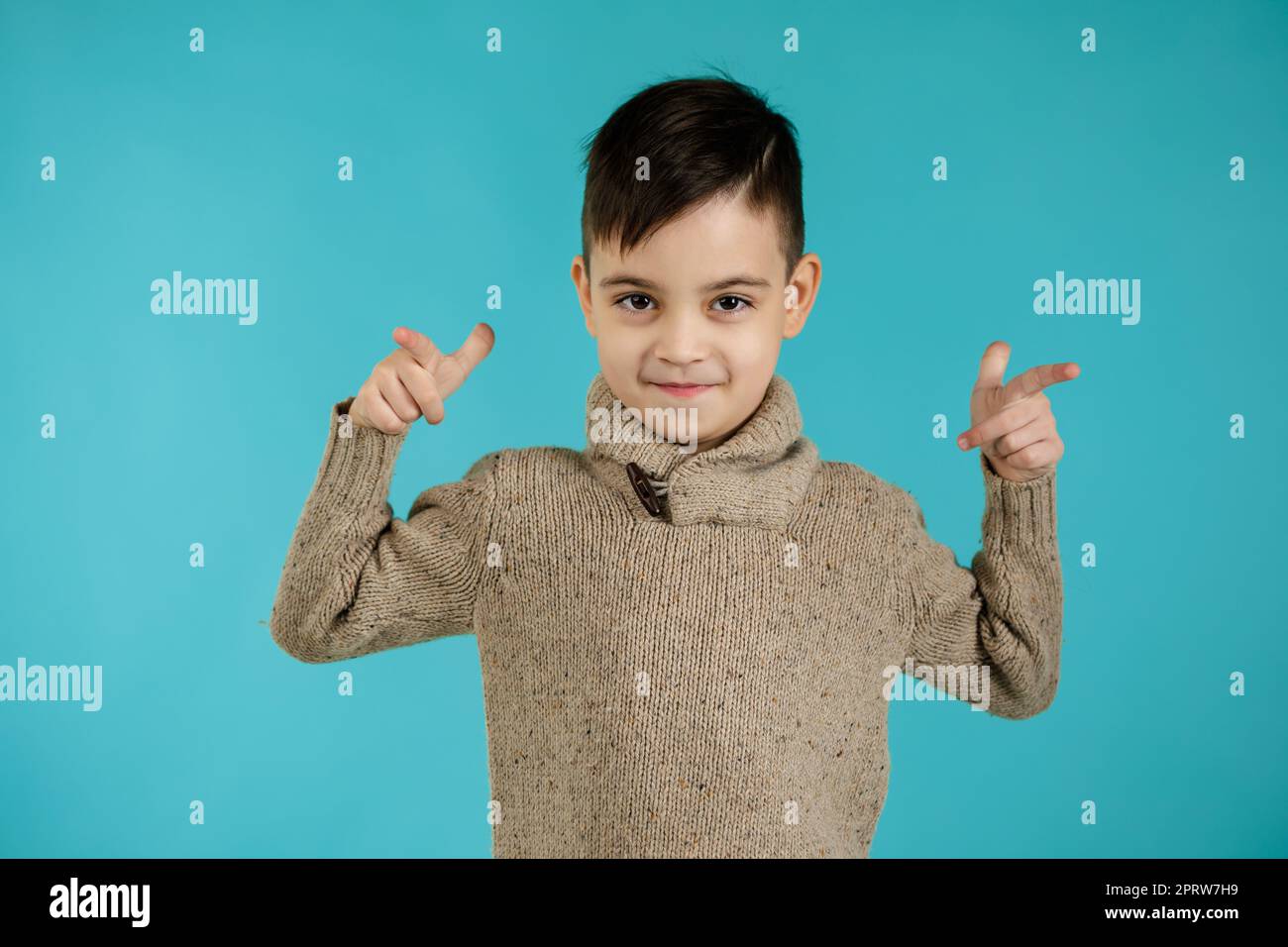 Cute little boy pointing camera on blue background. child pointing at ...