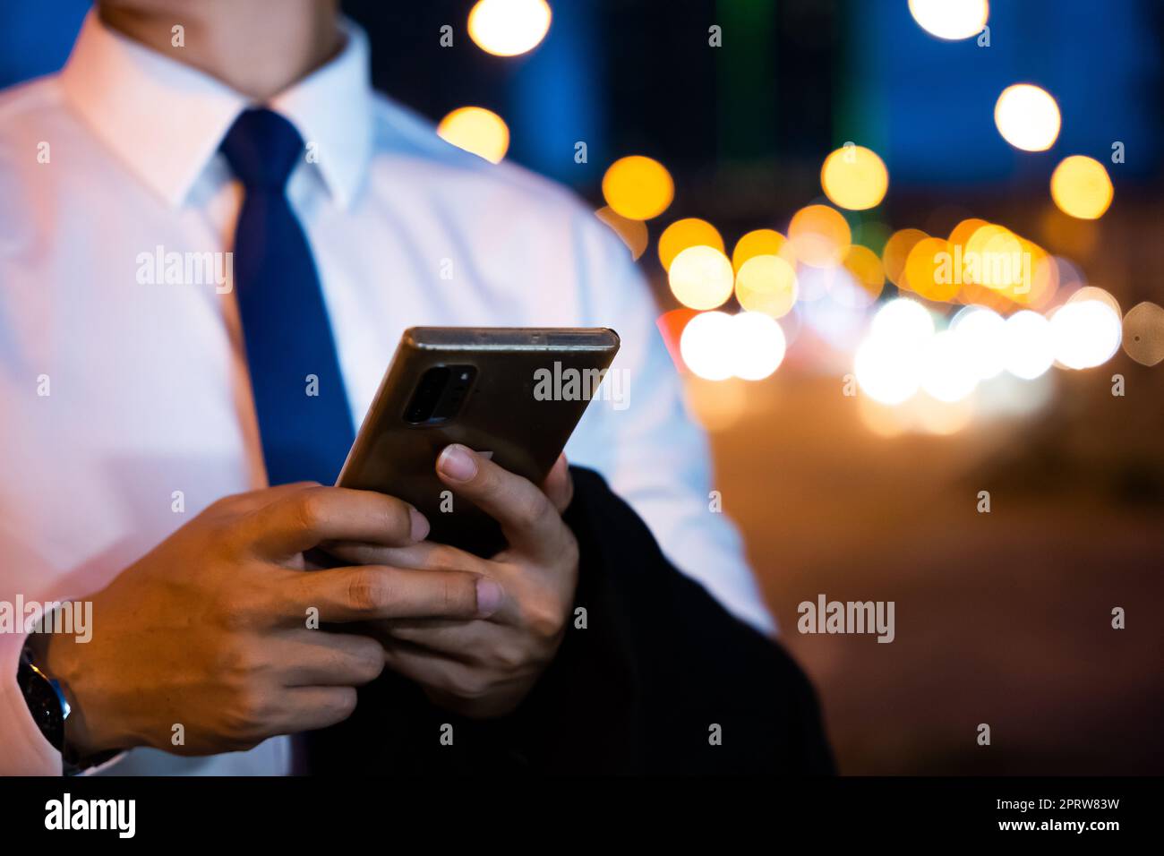 Hand using cell night office hi-res stock photography and images - Alamy