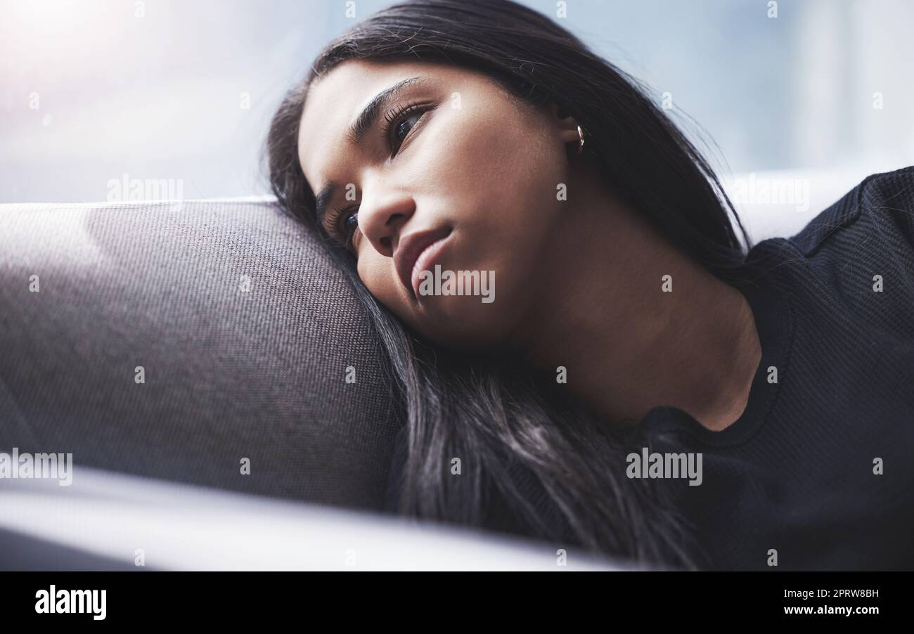 Depression, thinking and sad girl on sofa alone and hopeless with ...