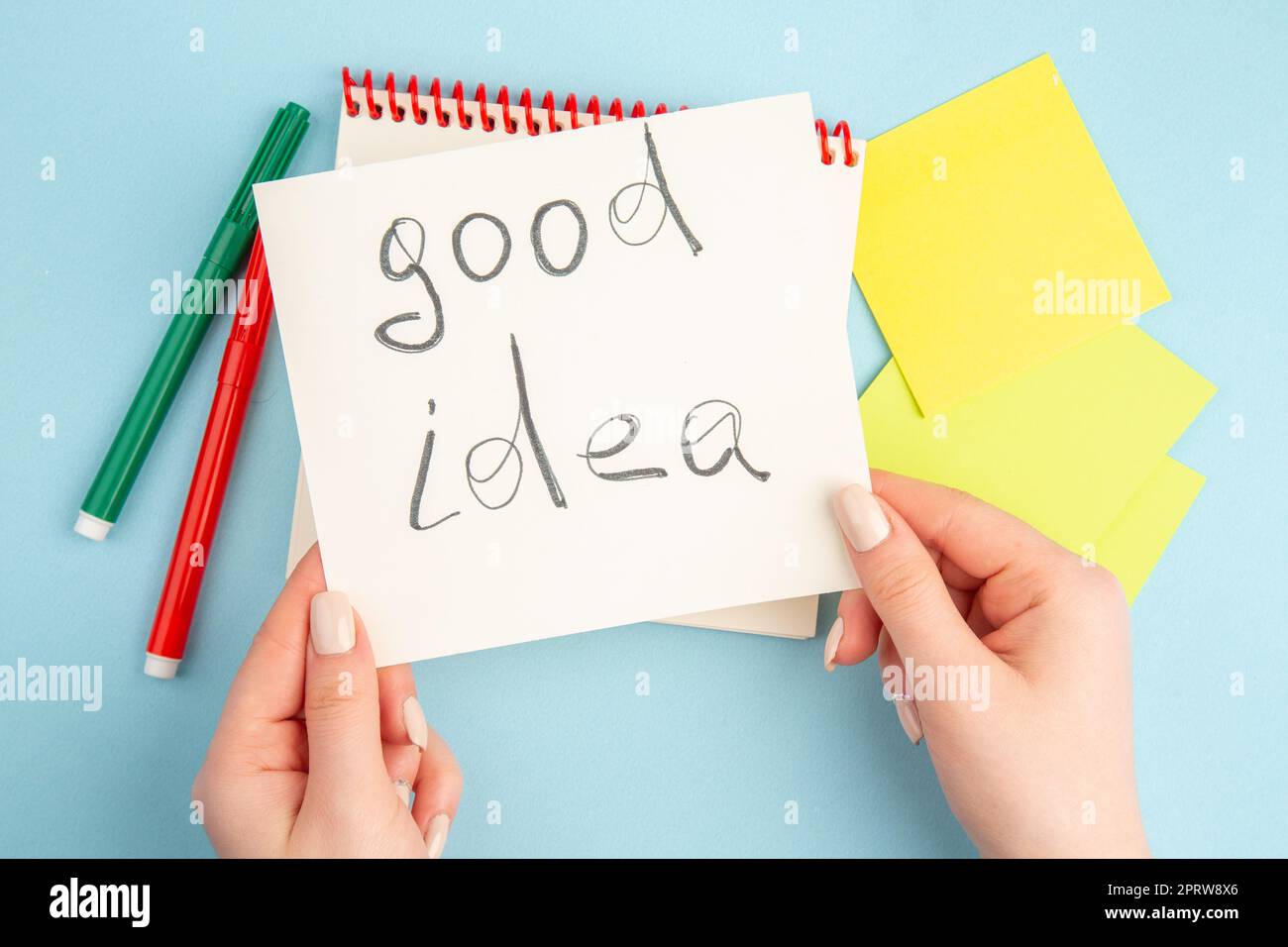 top view good idea written on sticky note in female hands markers on ...