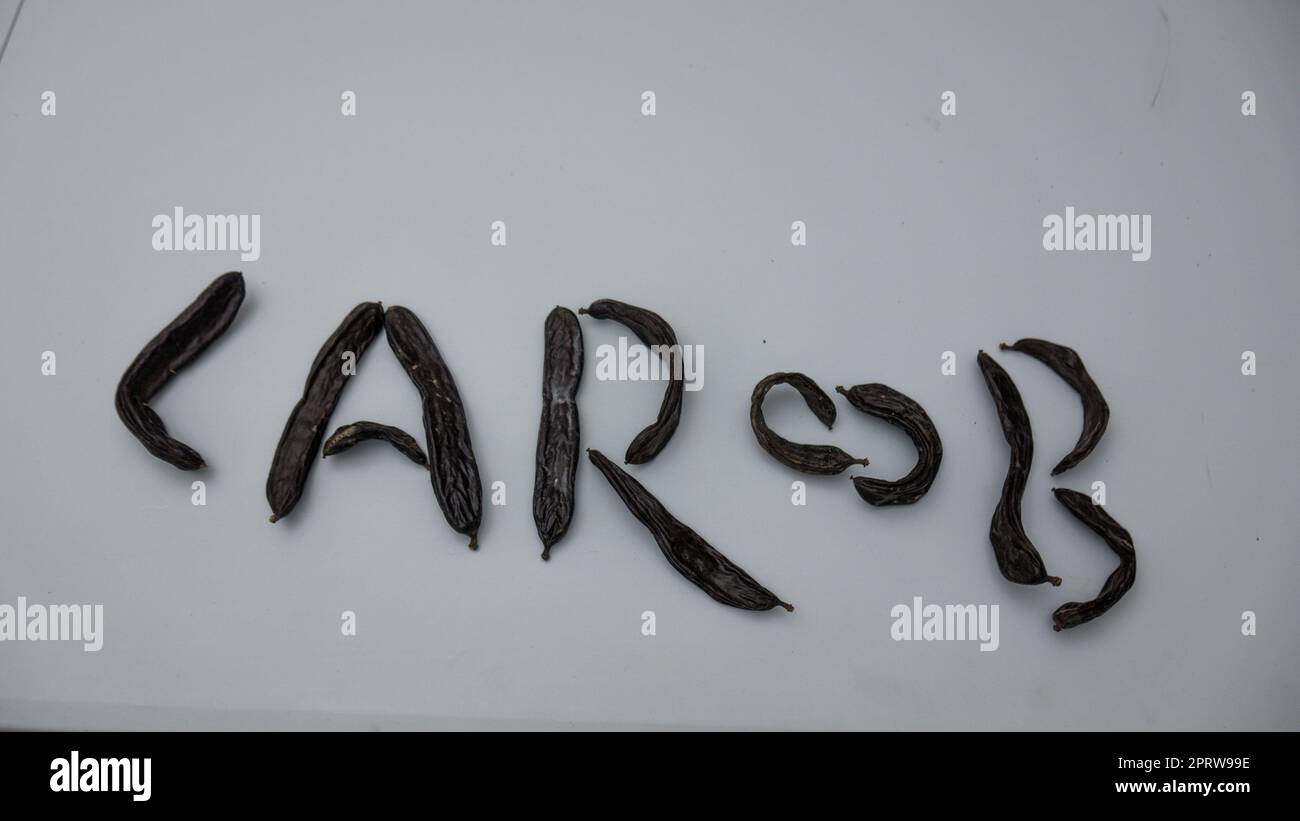 dried carob fruit on white background, typical autumn. carob mixed ...