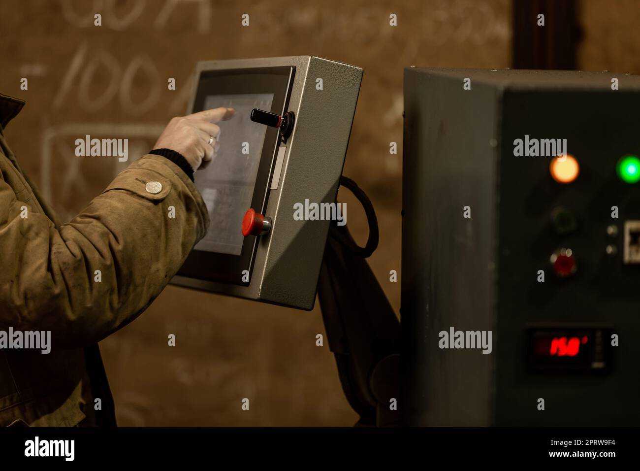 Worker operator using dashboard of CNC machinery or control at machine ...