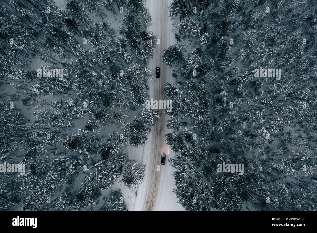 Aerial view of snowy road with cars, winter forest Stock Photo - Alamy