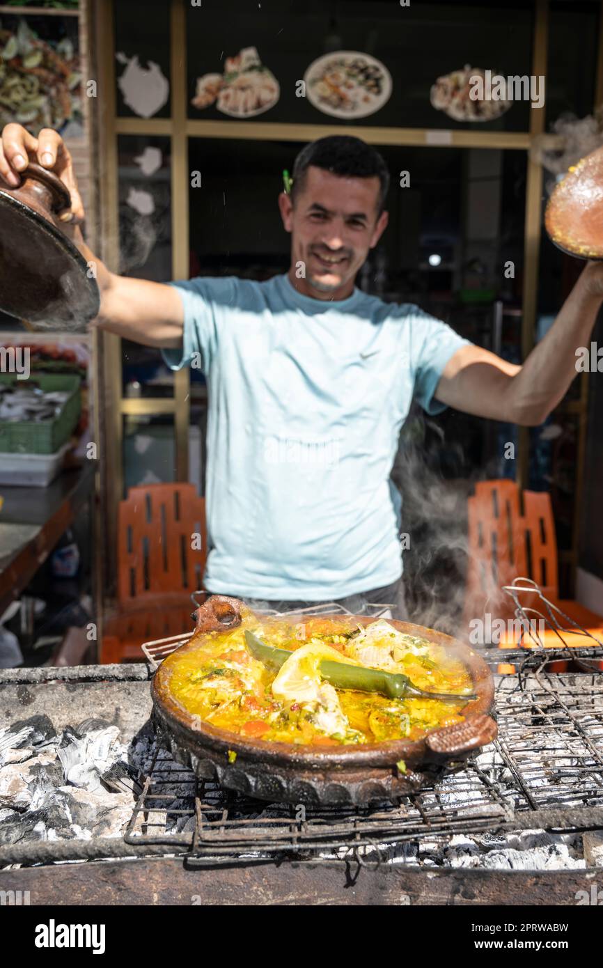 Man cooking the traditional tajine in a street restaurant in the ...