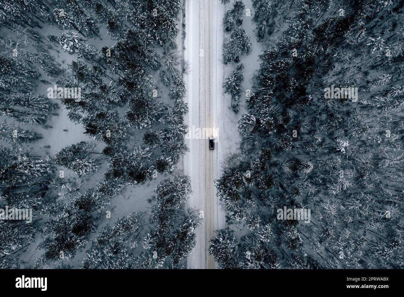 Aerial view of snowy road with cars, winter forest Stock Photo - Alamy