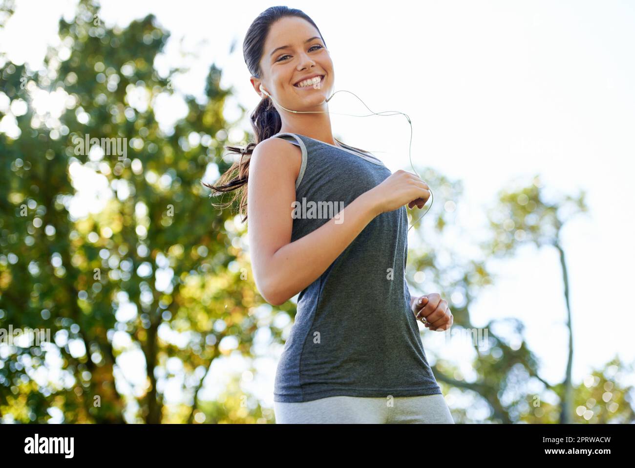 Sorry, got to run. a young woman running in the park Stock Photo - Alamy