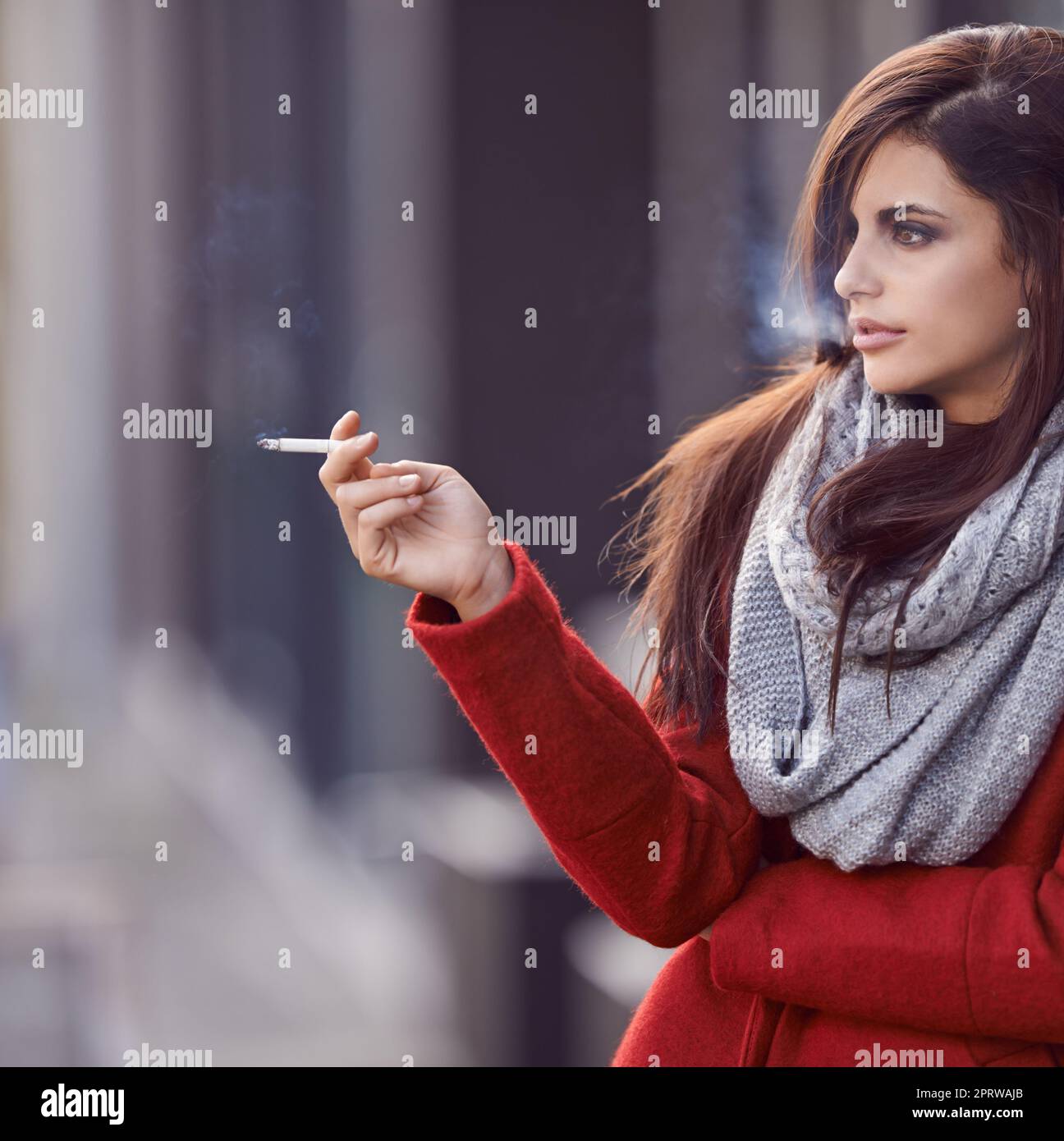 She Makes Bad Habits Look Good A Beautiful And Fashionable Young Woman Smoking A Cigarette In