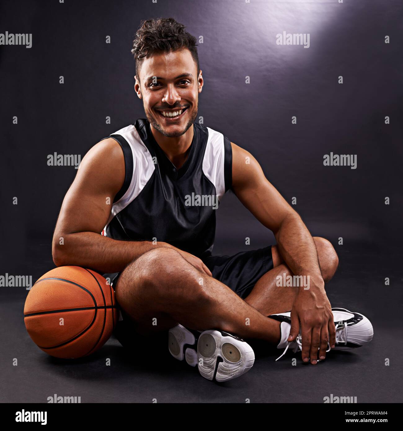 Ready for a game. Studio shot of a basketball player against a black ...