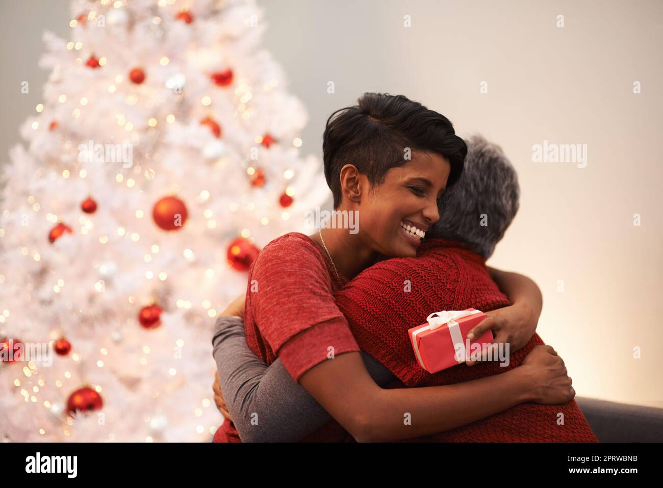 I love it. A senior woman receiving a hug from her daughter on ...