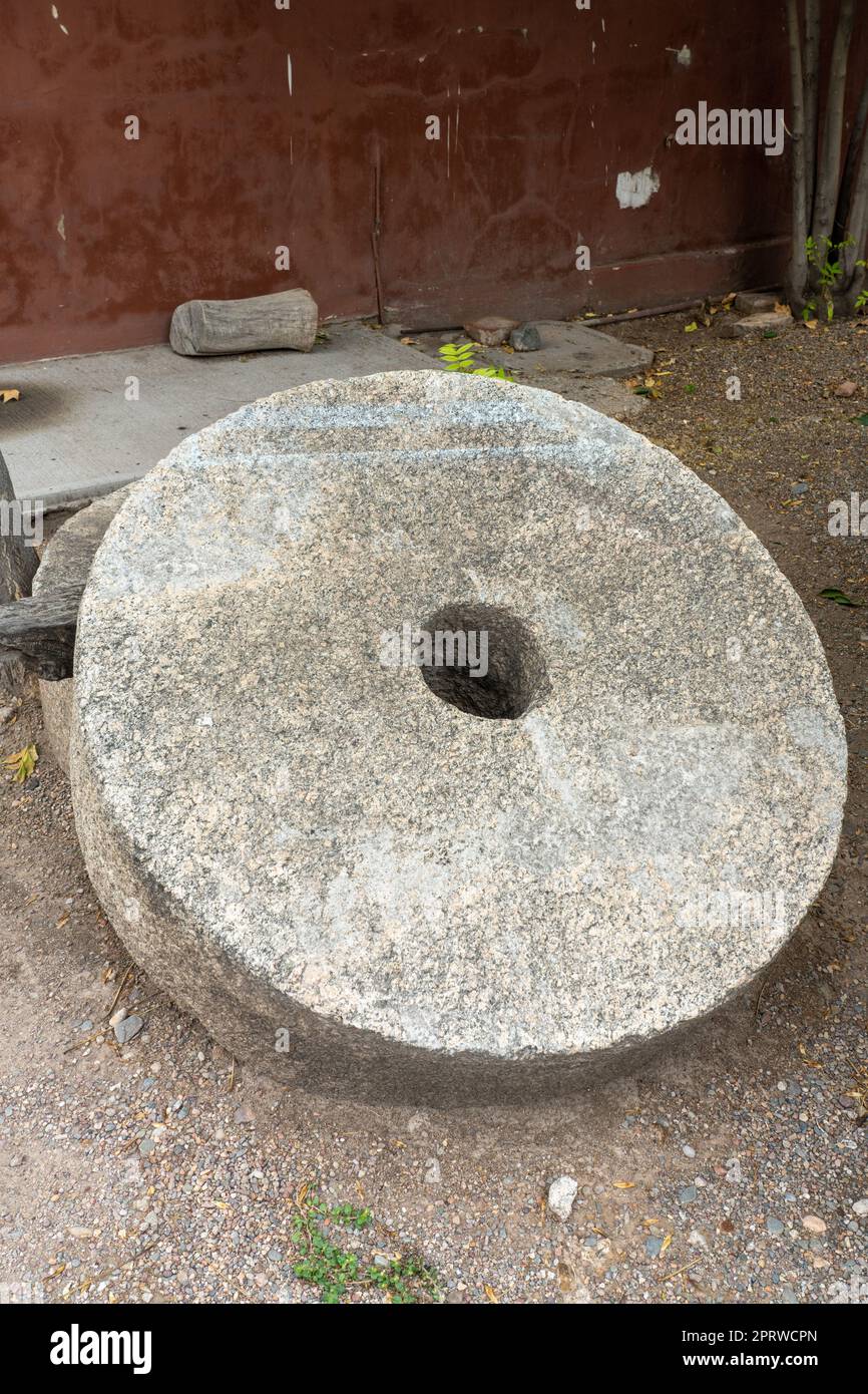 A stone grist wheel at the ruins of the church of San Francisco ...