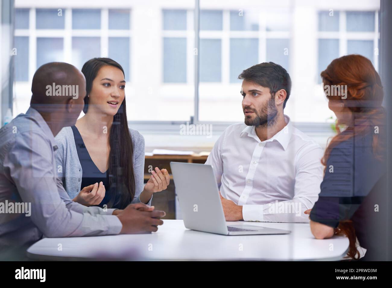 Throwing around some new ideas. A group of businesspeople having a meeting in a boardroom at ...