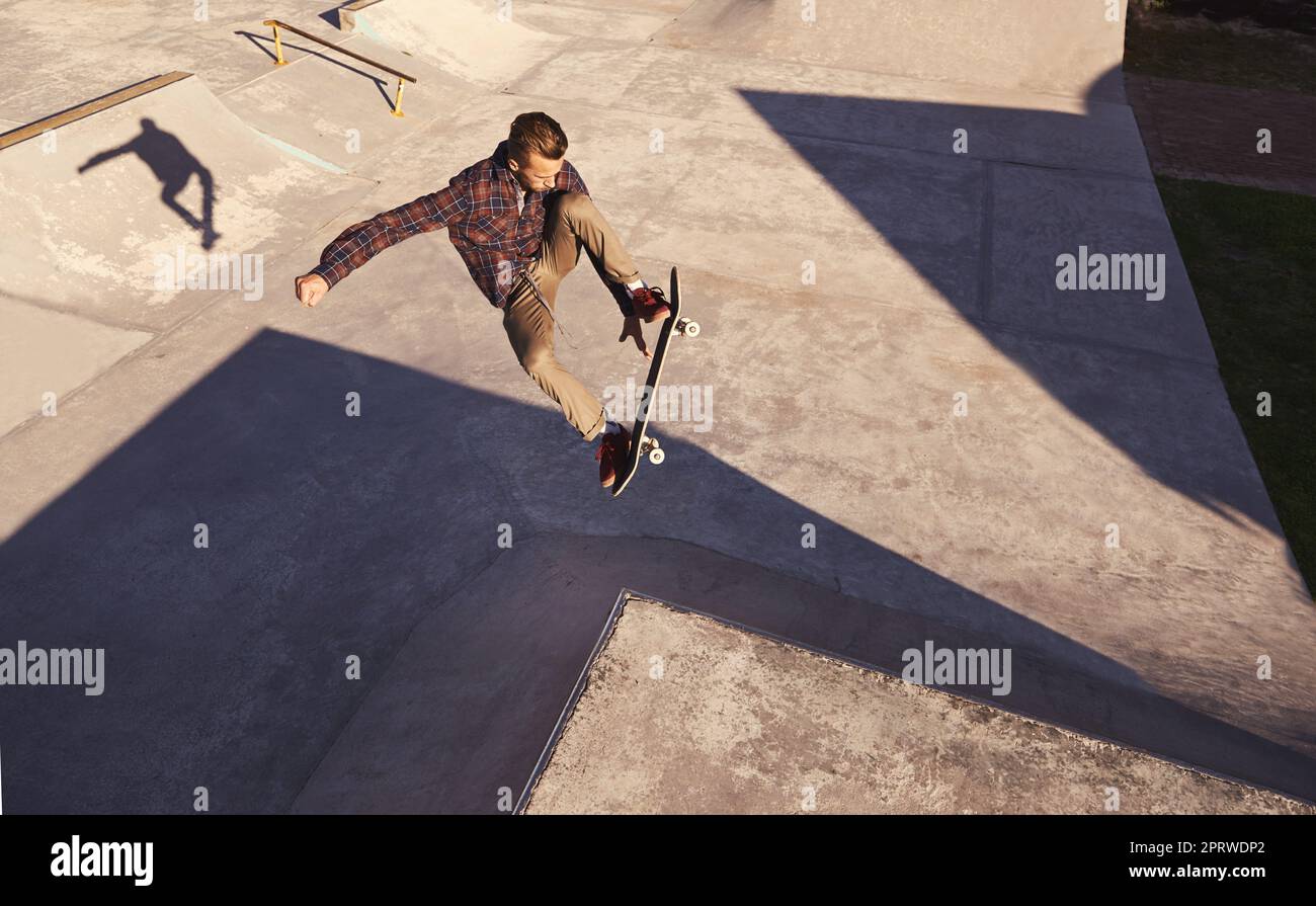 Living on the edge. A young man doing tricks on his skateboard at the ...