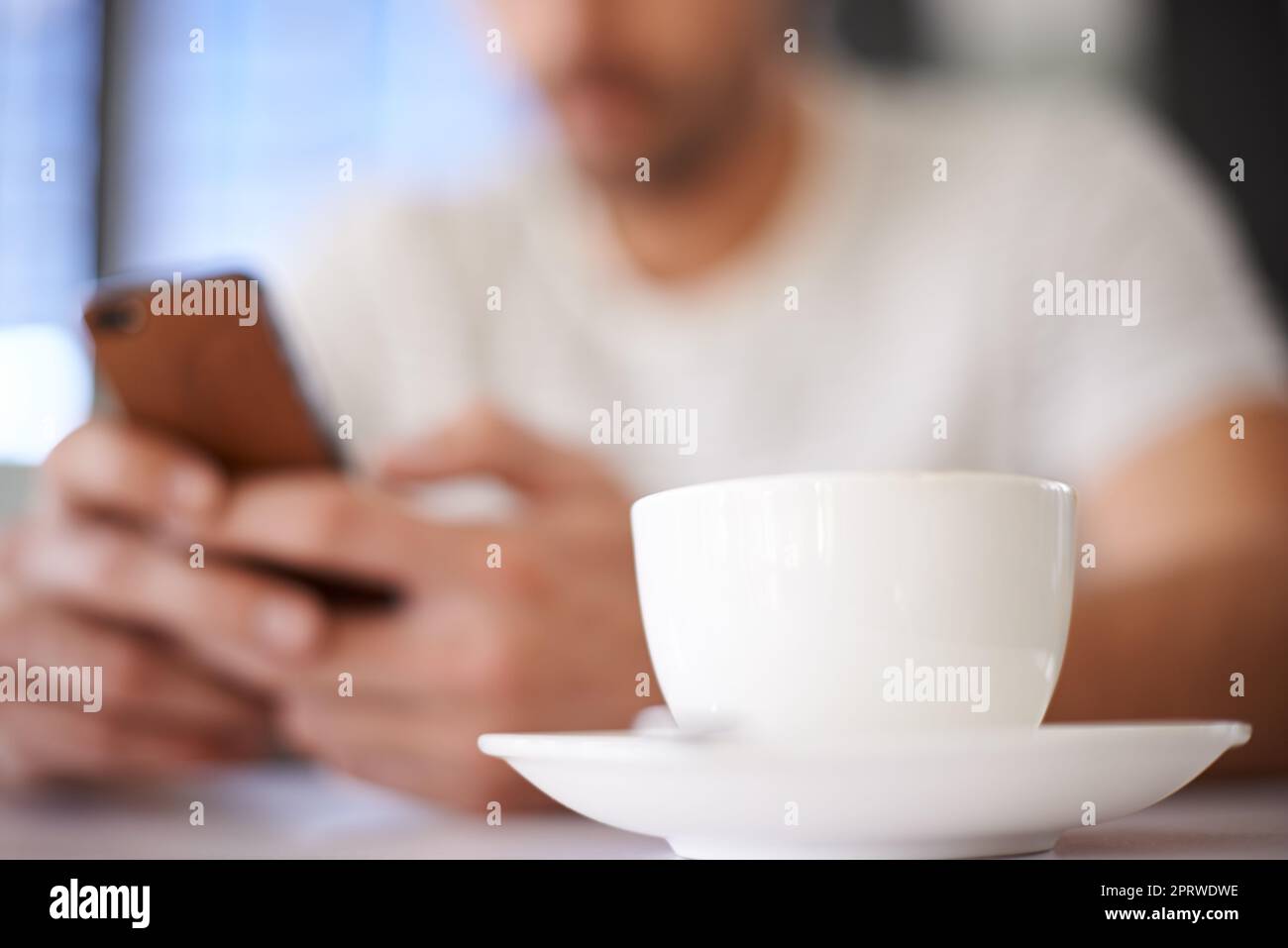 I got us a table. a man using his mobile phone while sitting at a ...