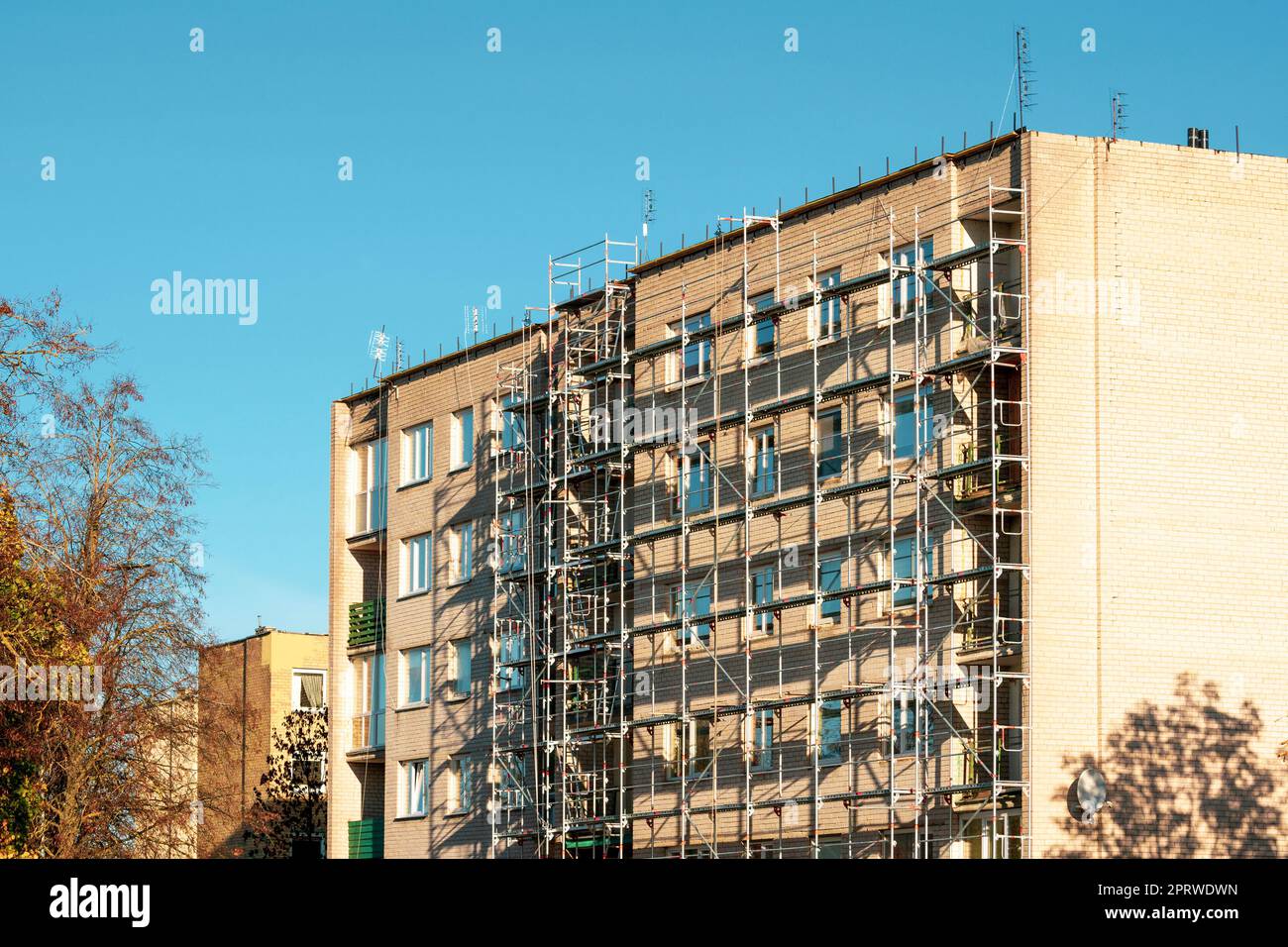 External wall thermal insulation with wool, scaffolding around the ...