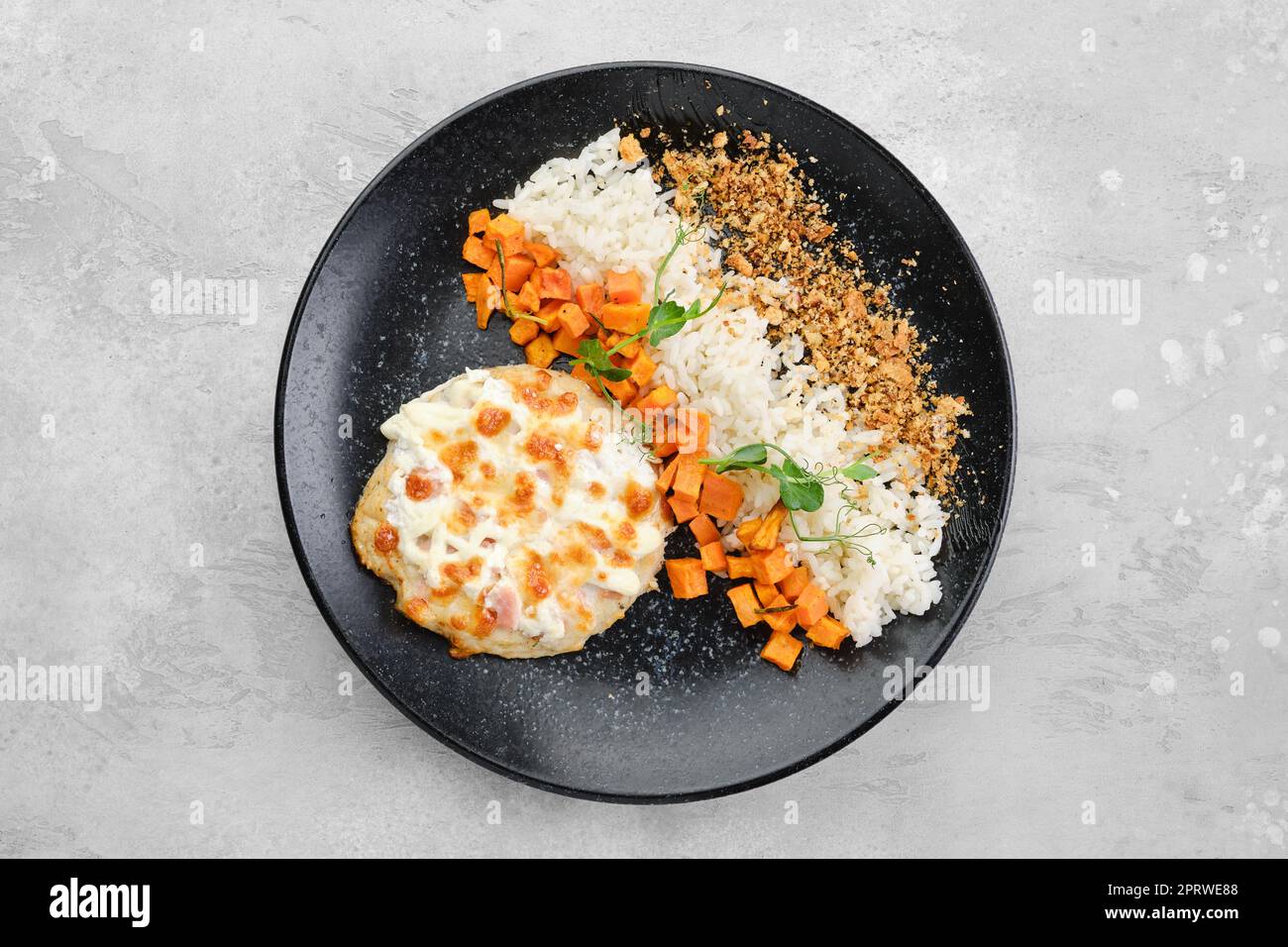 Chopped pork cutlet baked with ham and cheese served with carrot and ...